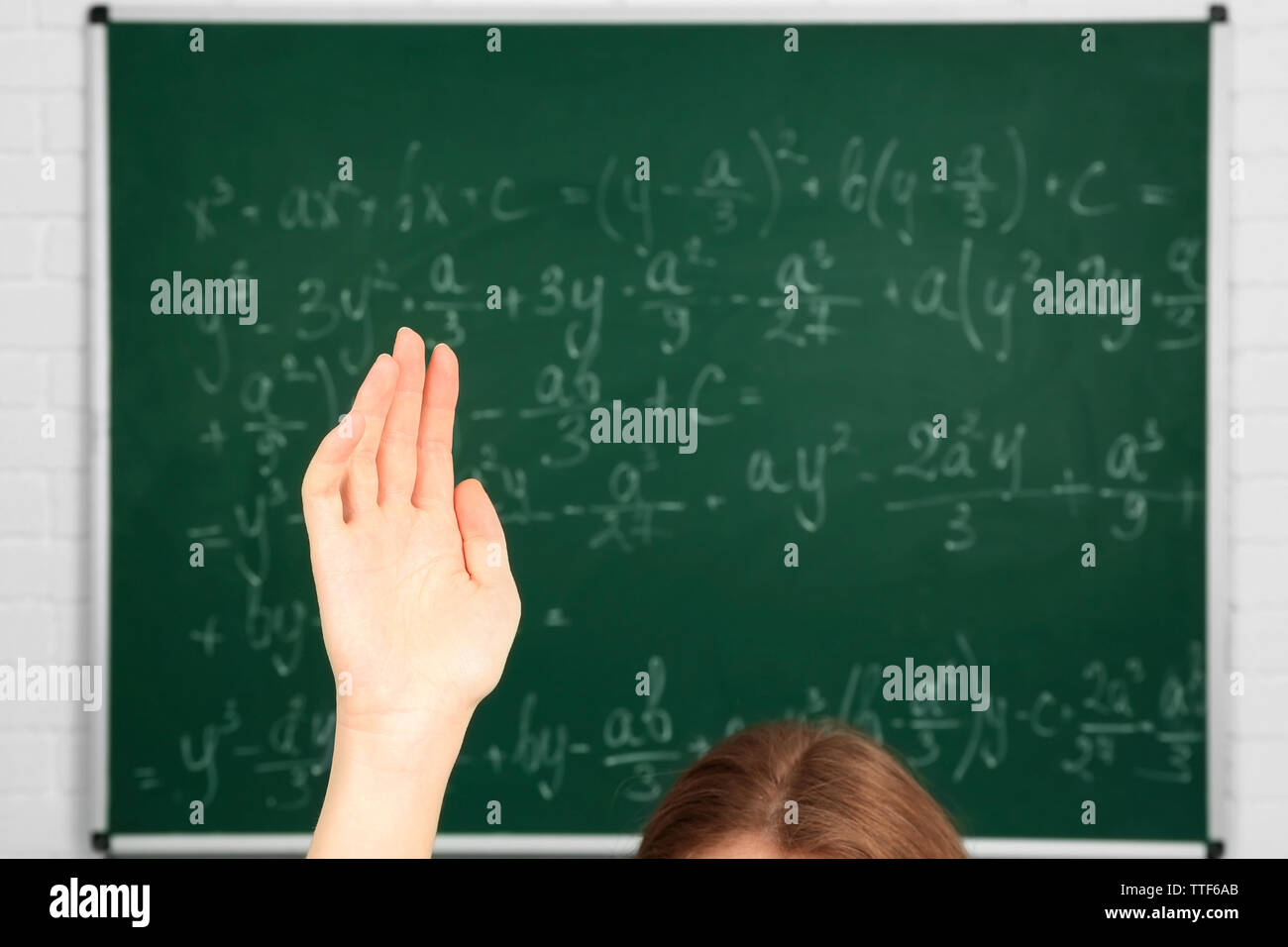 Raised hand on blackboard background in class Stock Photo - Alamy