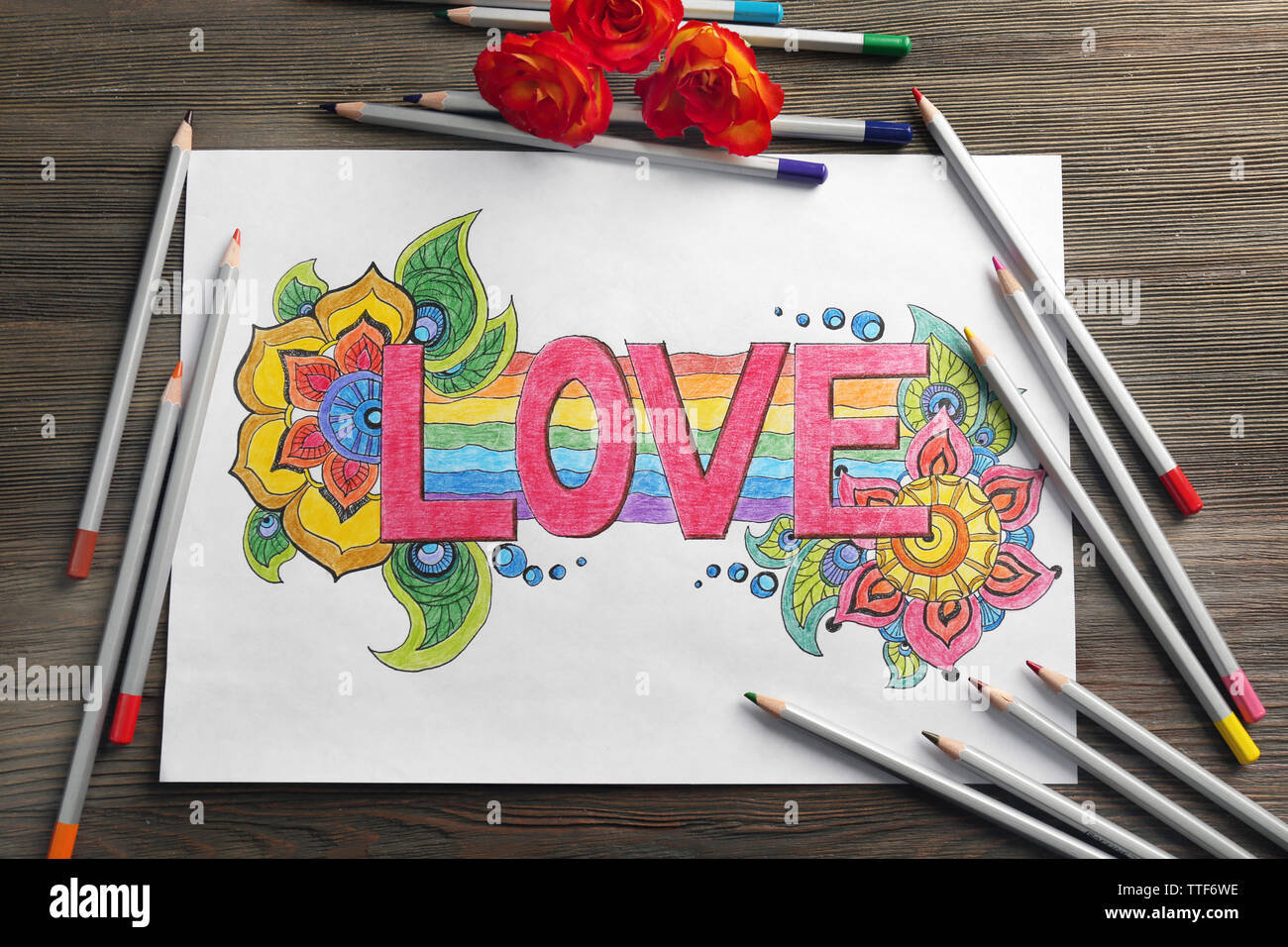 Bright picture with word LOVE, crayons and roses, close up Stock Photo ...