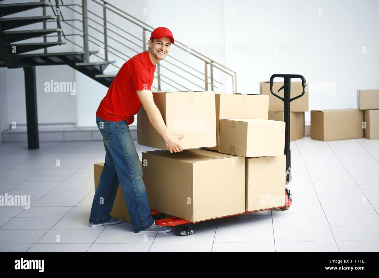 Delivery man with hand truck, close up Stock Photo - Alamy