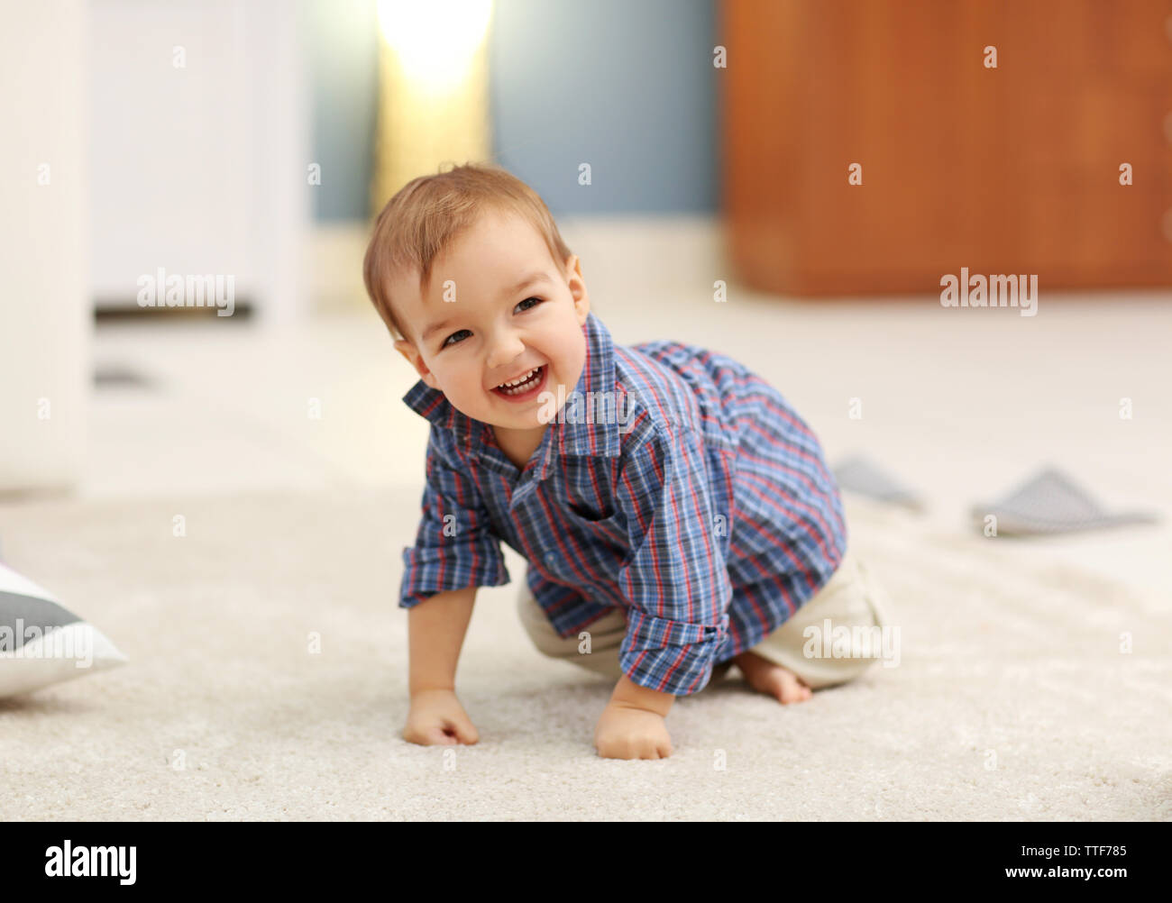 Cute baby on the floor in the room Stock Photo - Alamy