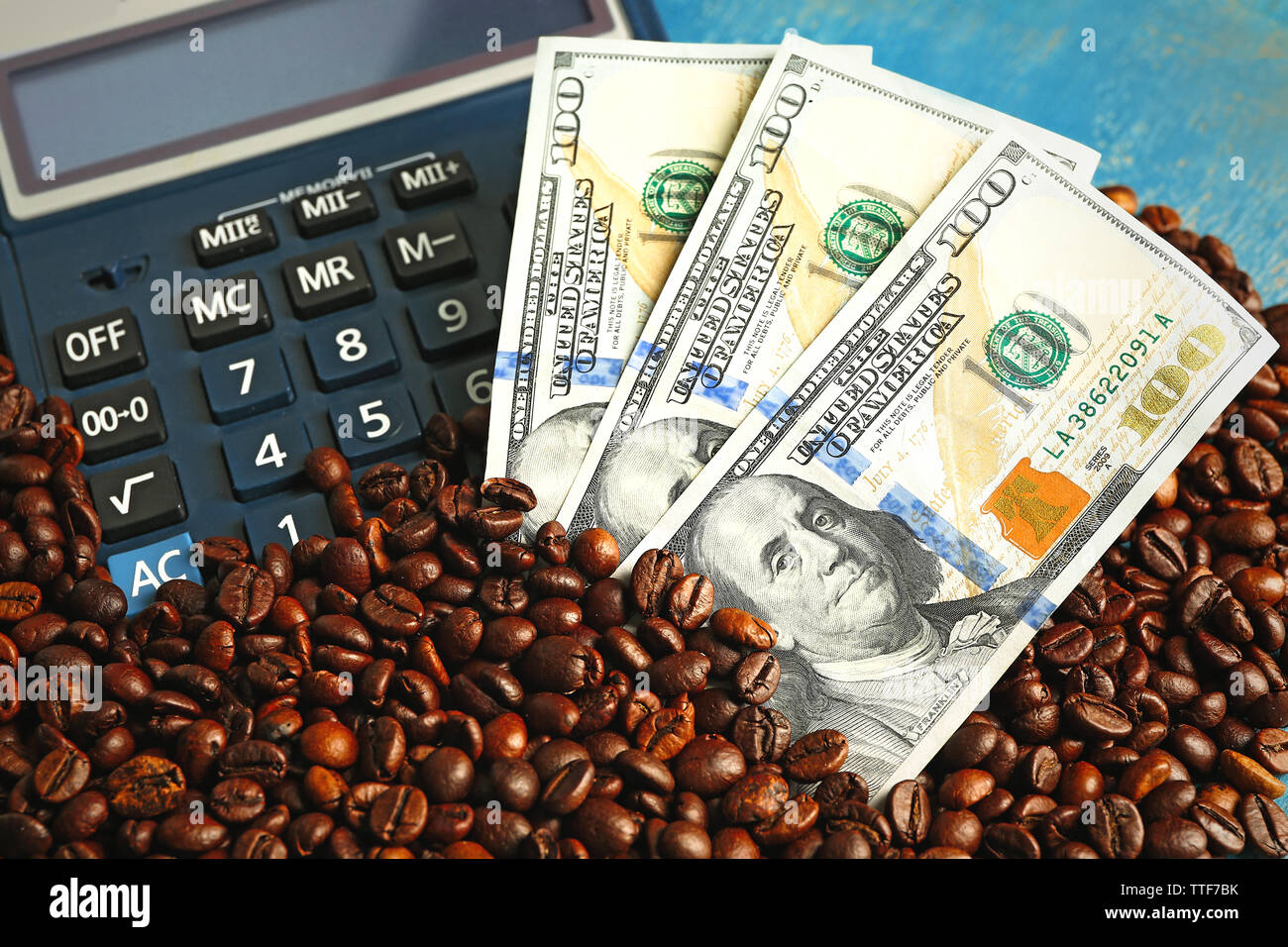 Coffee beans and US dollar banknotes and calculator, close-up Stock ...
