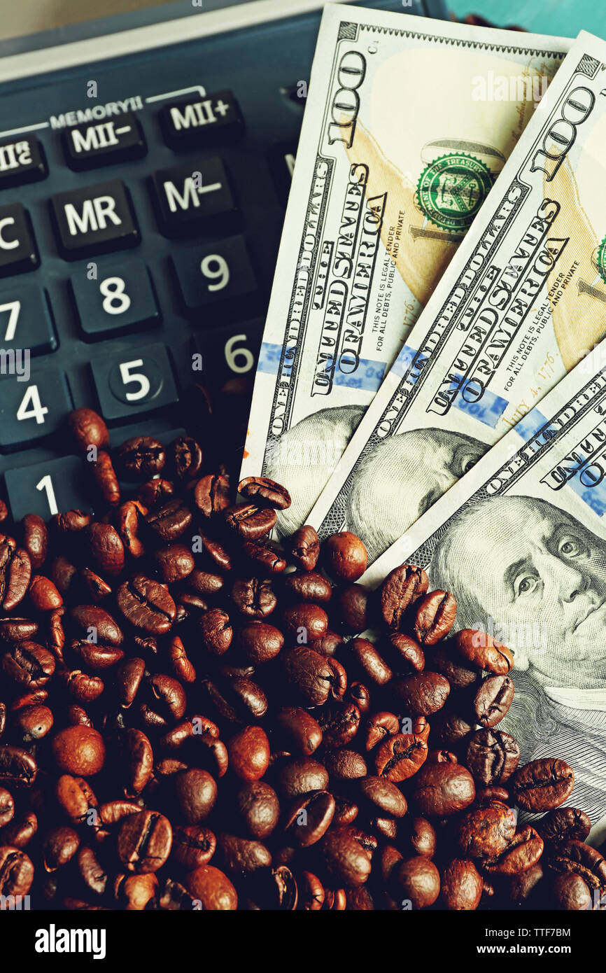 Coffee beans and US dollar banknotes and calculator, close-up Stock ...
