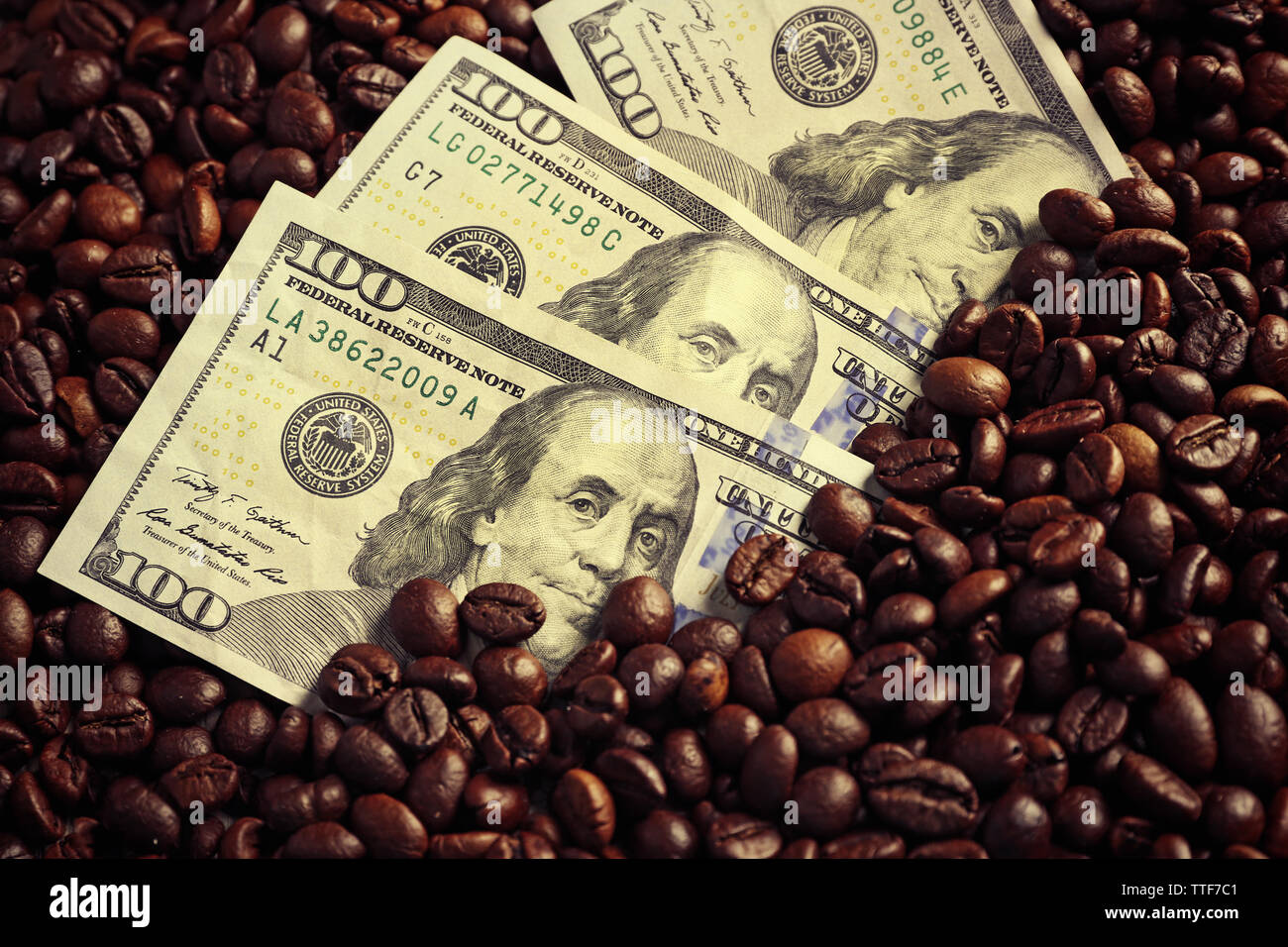 Coffee beans and US dollar banknotes on color wooden background Stock ...