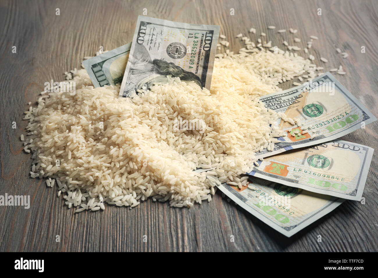 Dollar banknotes and rice grains on wooden background. Agricultural ...