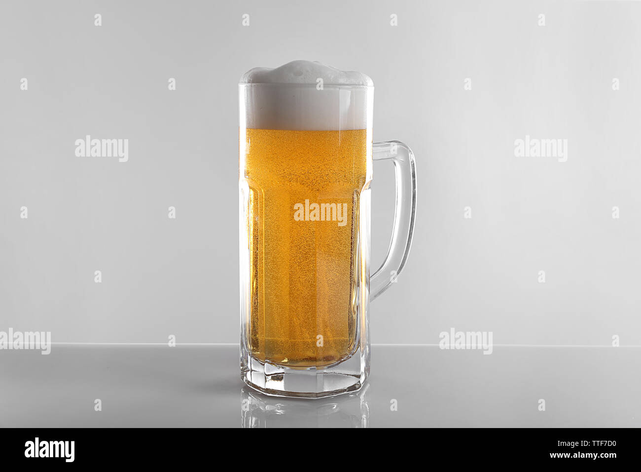 Glass of lager beer on light grey background Stock Photo - Alamy