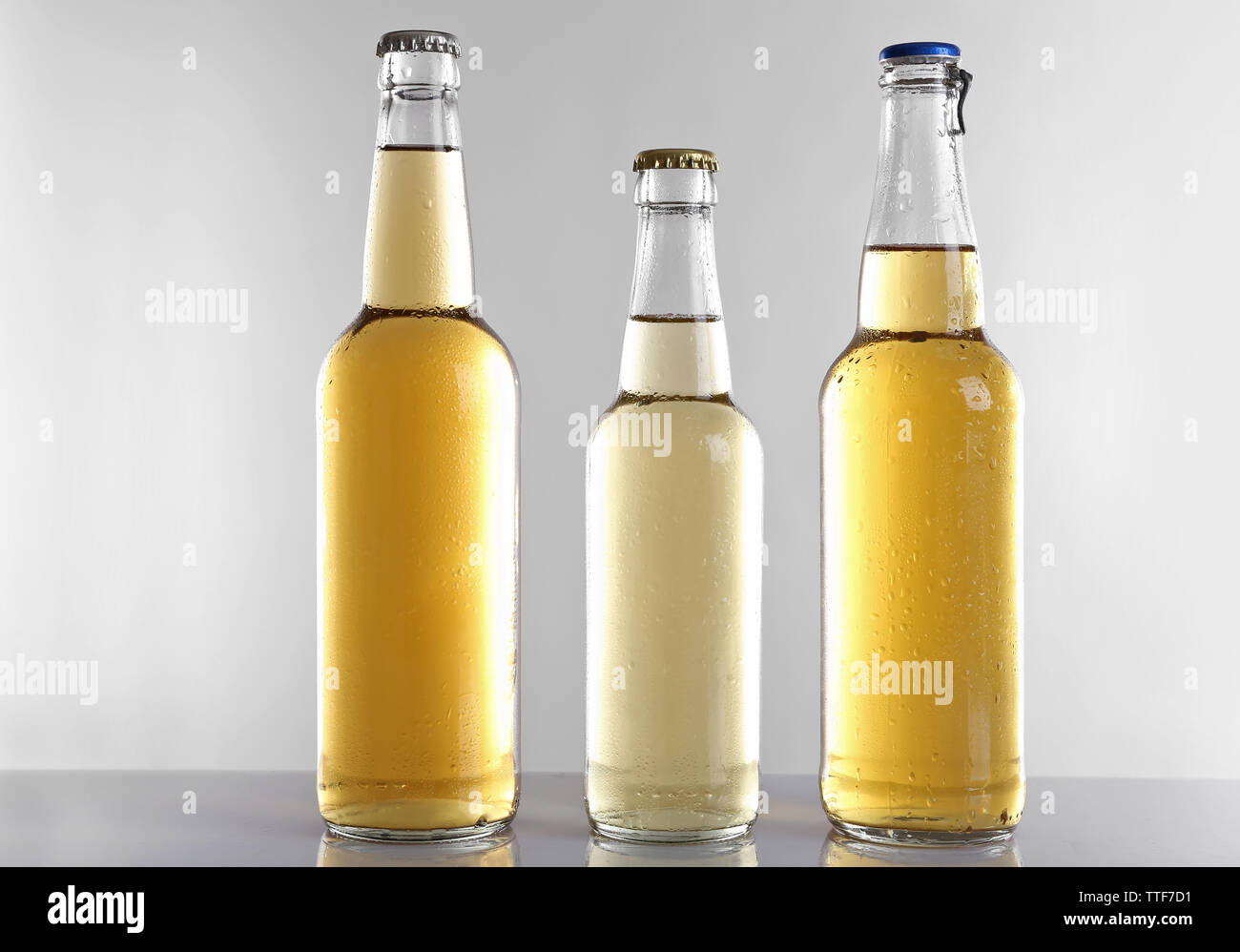Glass bottles of lager beer on light grey background Stock Photo - Alamy