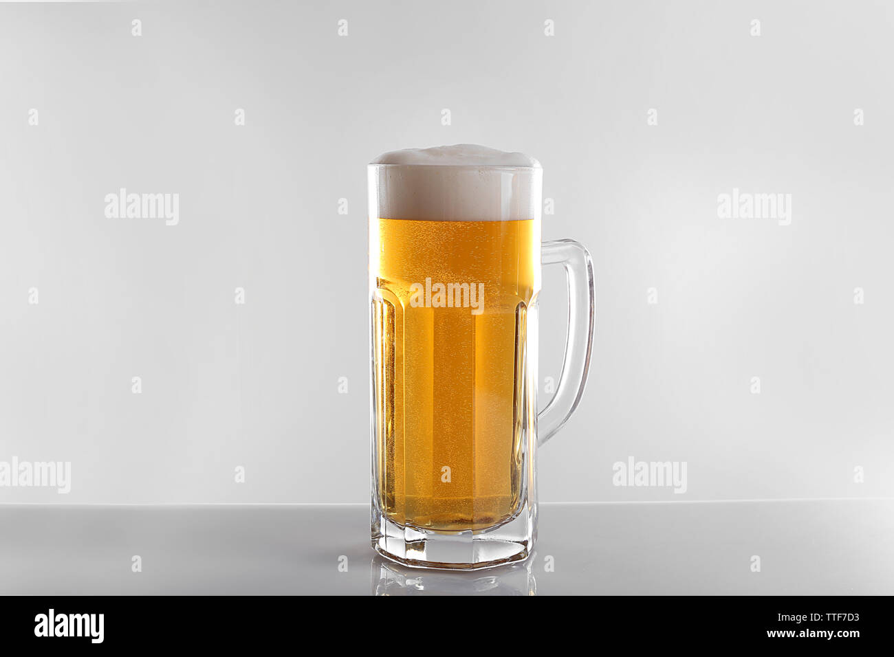 Glass of lager beer on light grey background Stock Photo - Alamy