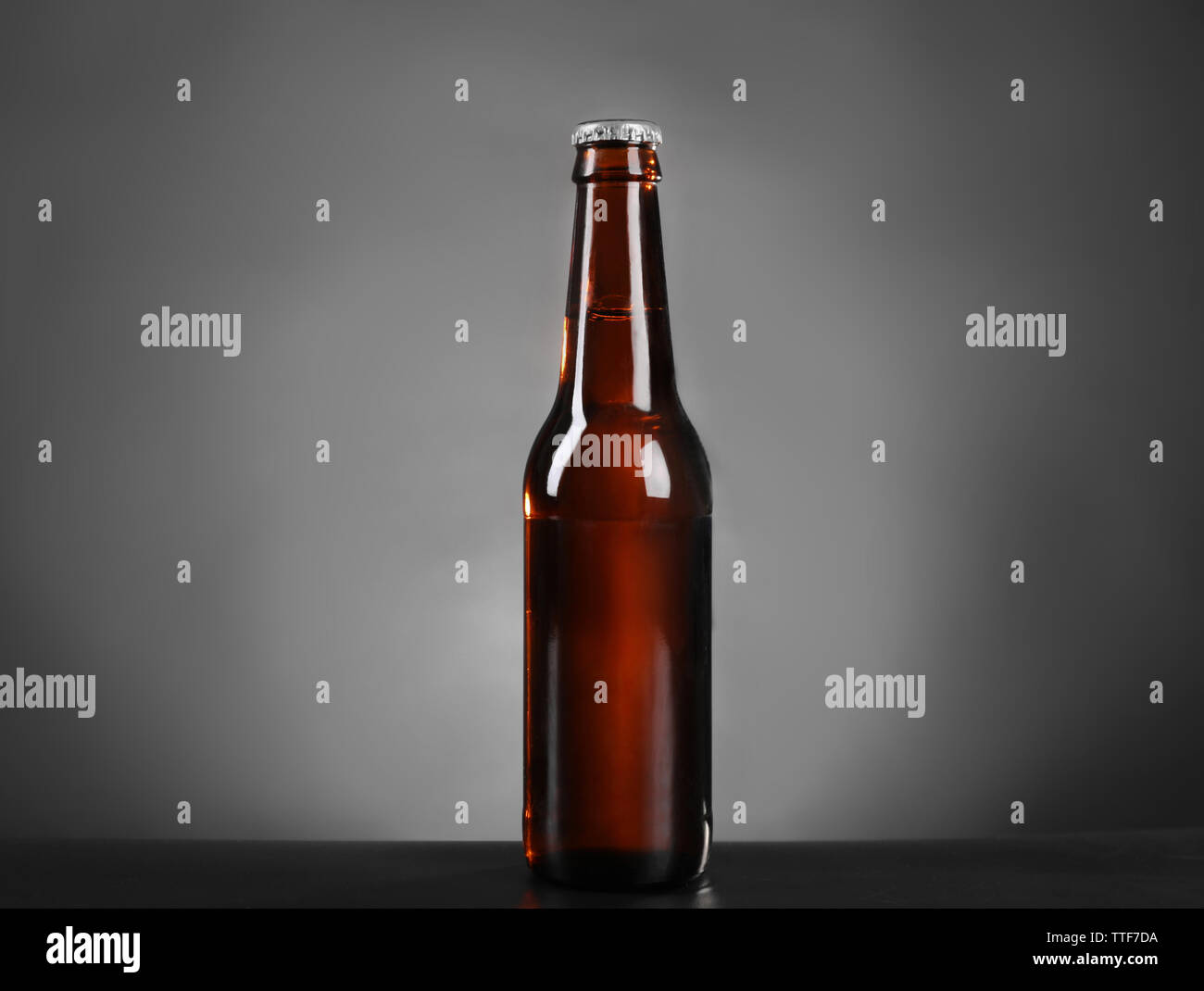 Glass bottle of dark beer on grey background Stock Photo - Alamy