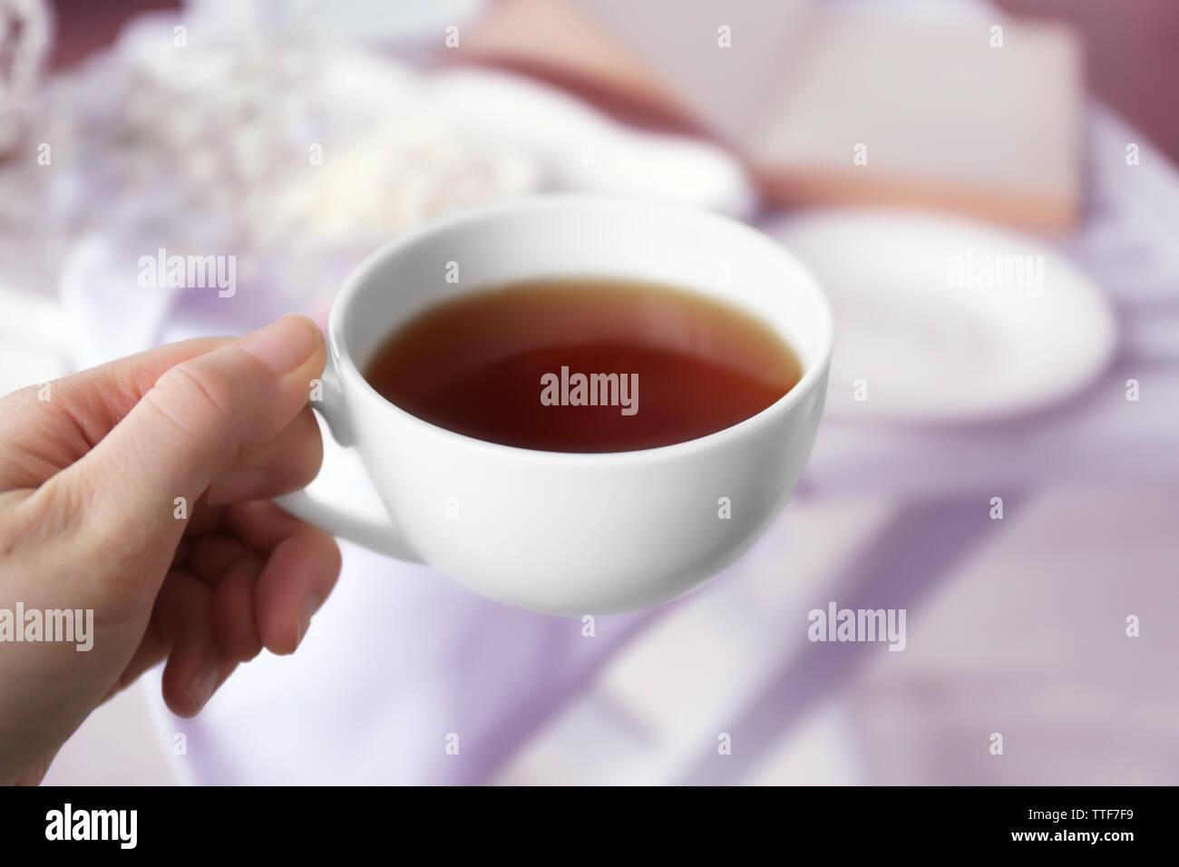 Hand holding cup of tea, close up Stock Photo - Alamy