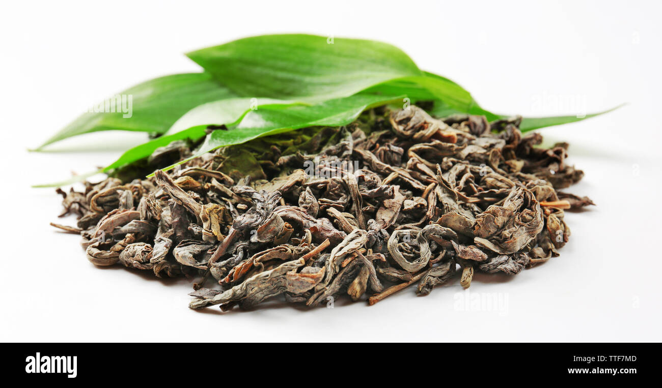 Pile of dry tea with green leaves, isolated on white Stock Photo - Alamy