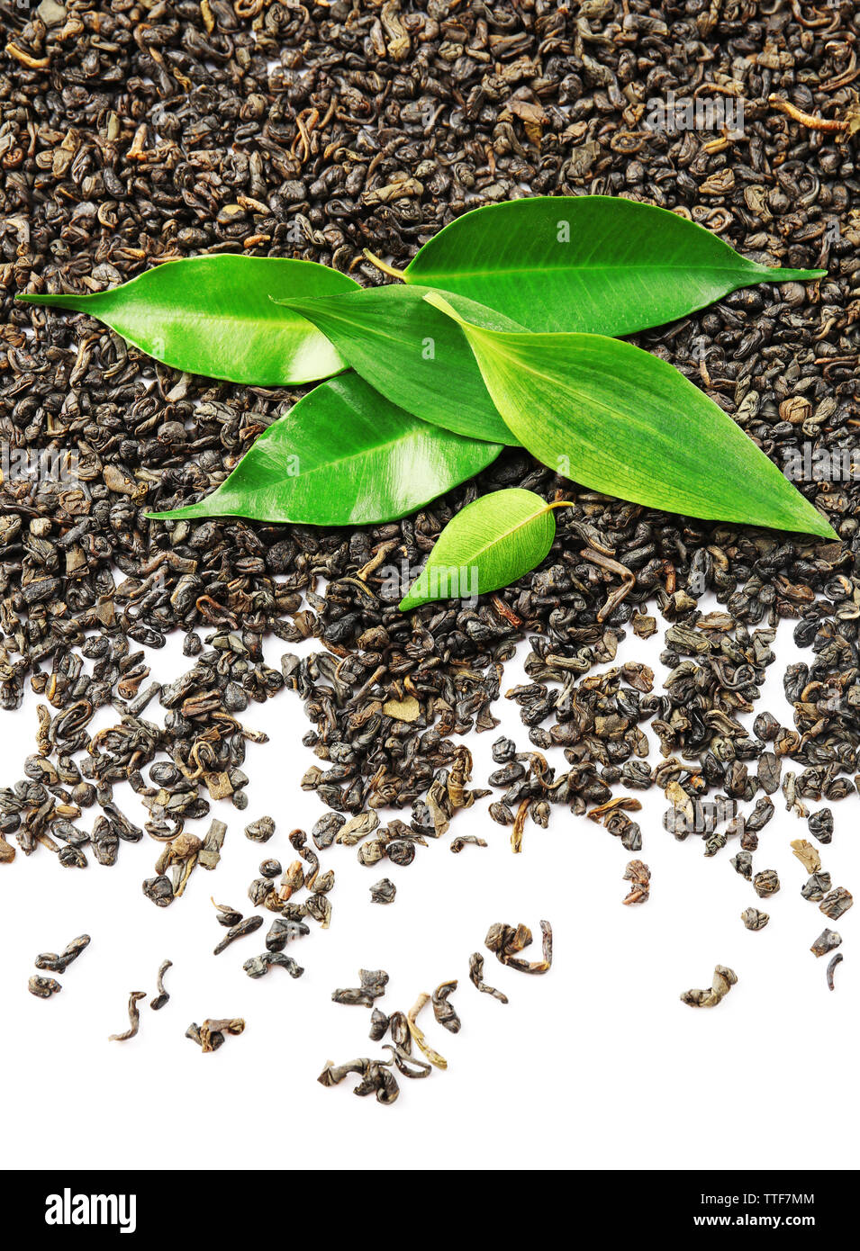 Pile of dry tea with green leaves on white background Stock Photo - Alamy