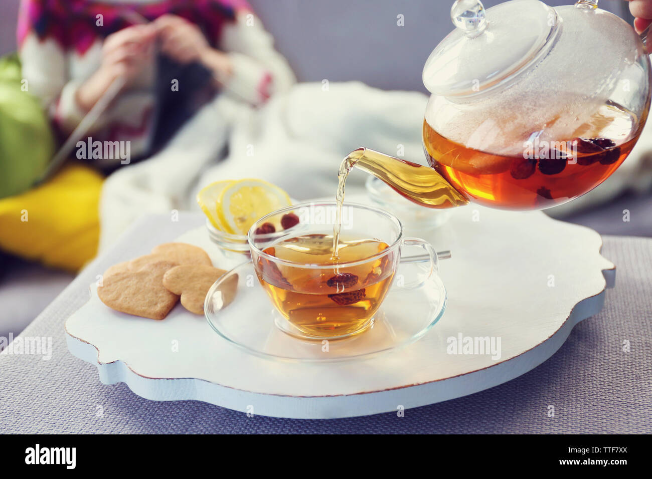 Pouring tea into cup, home atmosphere Stock Photo - Alamy