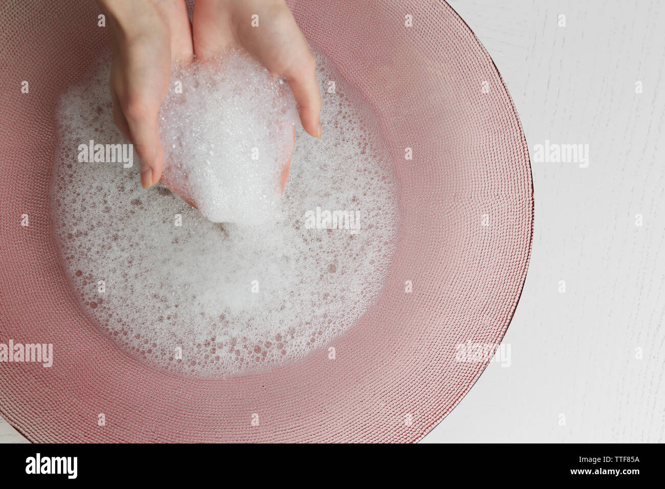 Woman washing hands in bowl isolated on white Stock Photo - Alamy