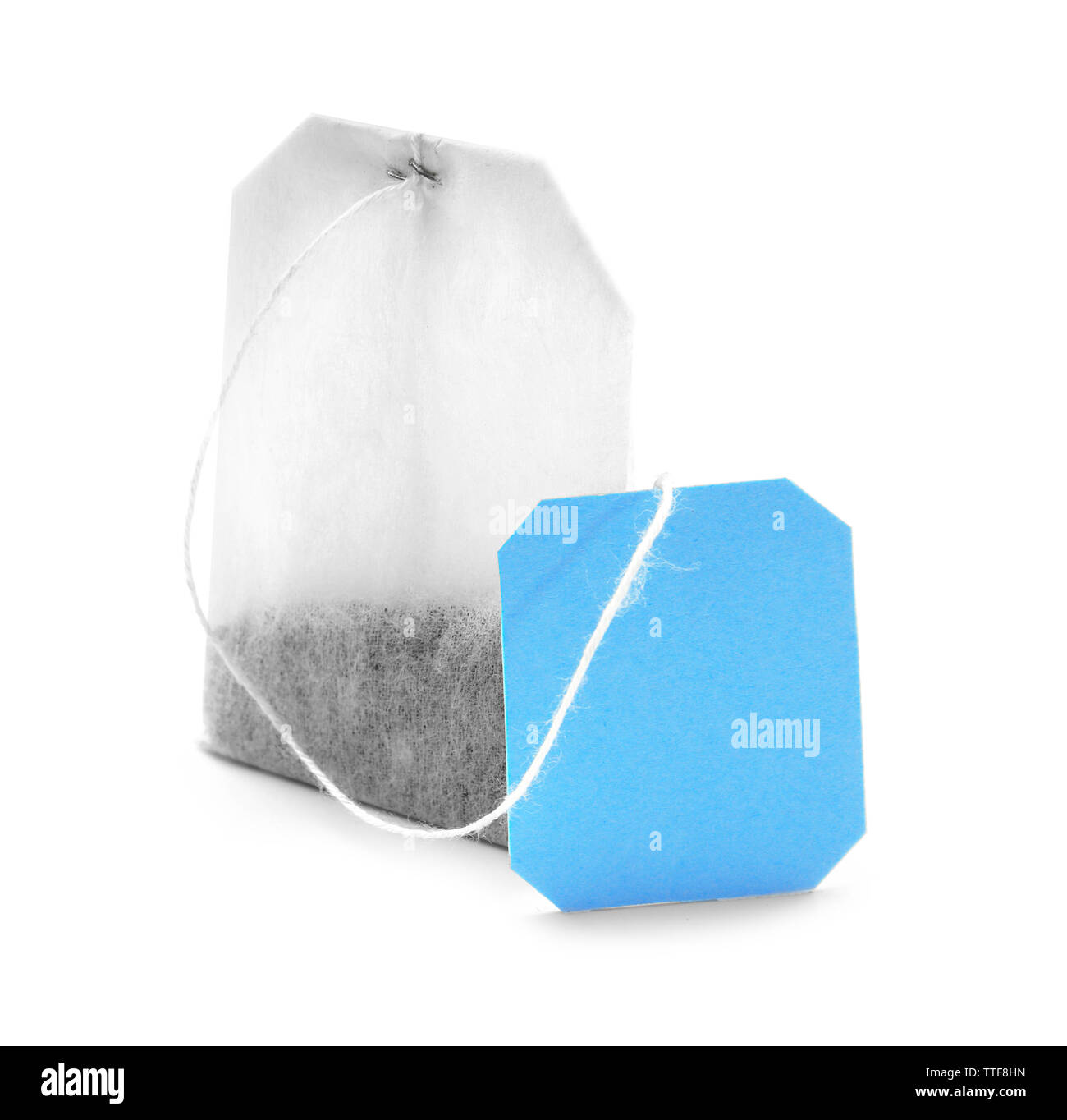 Teabag with blue label isolated on white background Stock Photo - Alamy