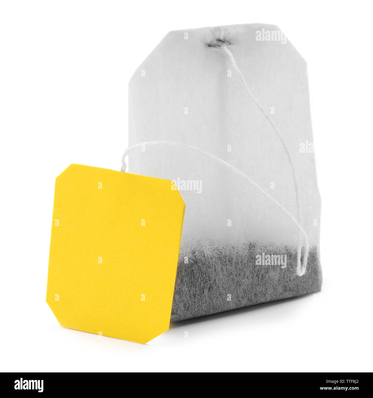 Teabag with yellow label isolated on white background Stock Photo - Alamy