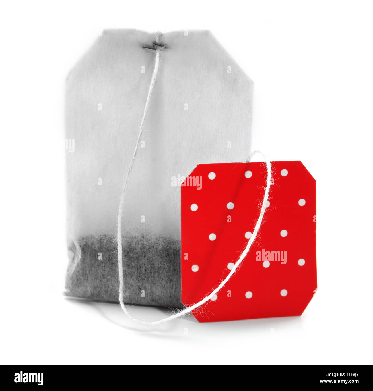 Teabag with red dotted label isolated on white background Stock Photo ...