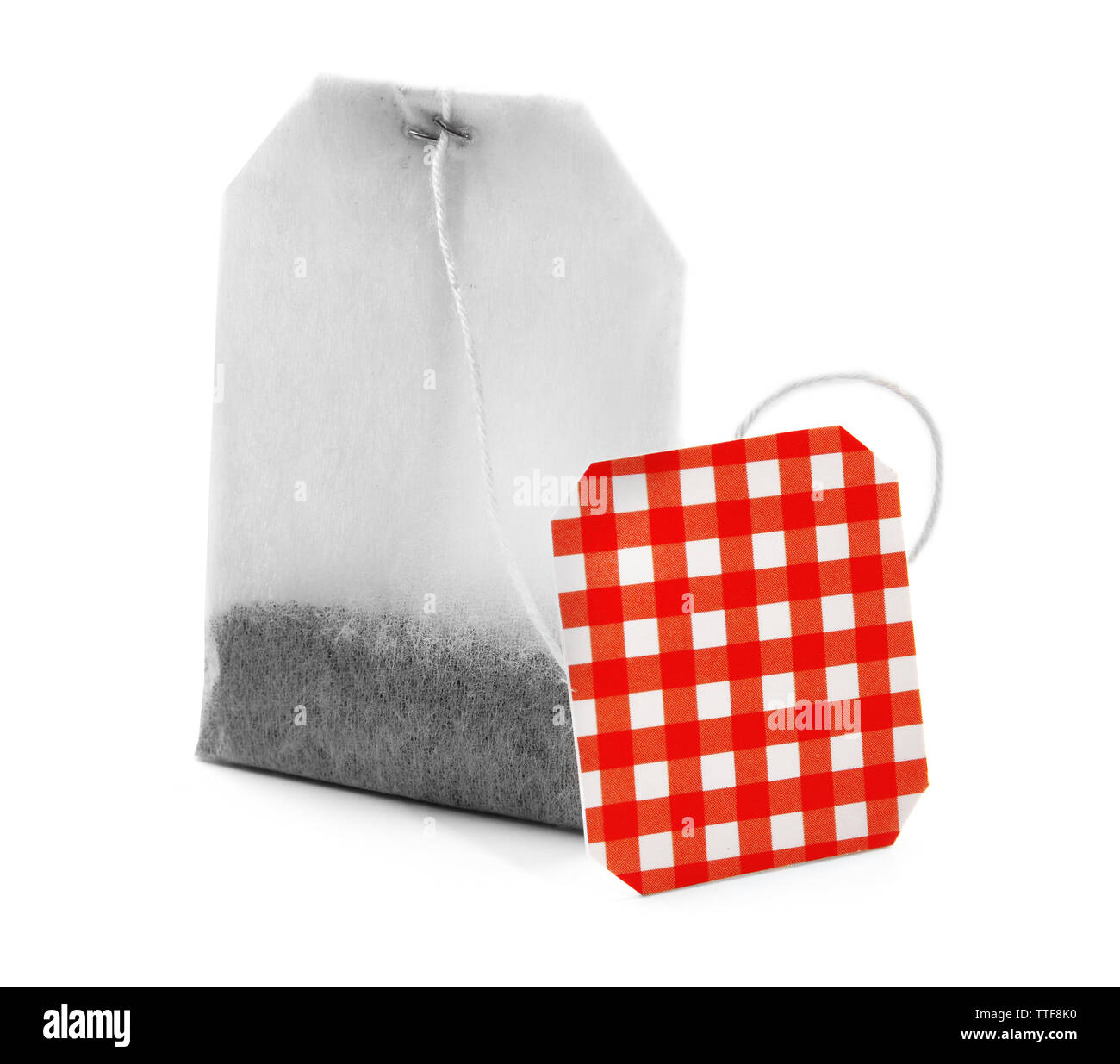 Teabag with red checkered label isolated on white background Stock ...