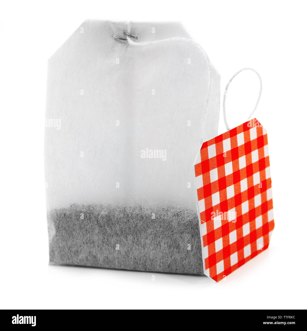 Teabag with red checkered label isolated on white background Stock ...
