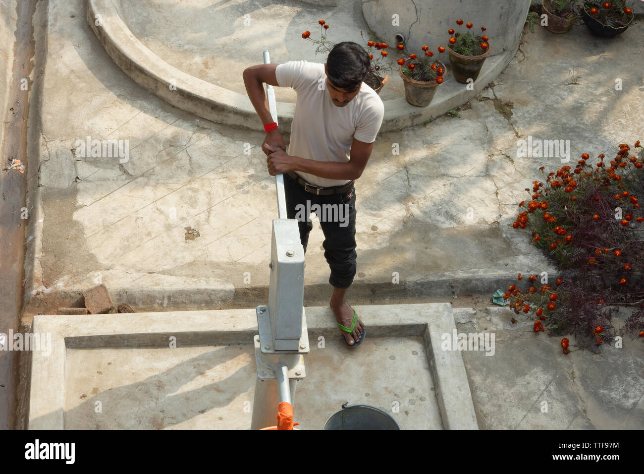 An Indian man pumping a water tube well, top view Stock Photo - Alamy