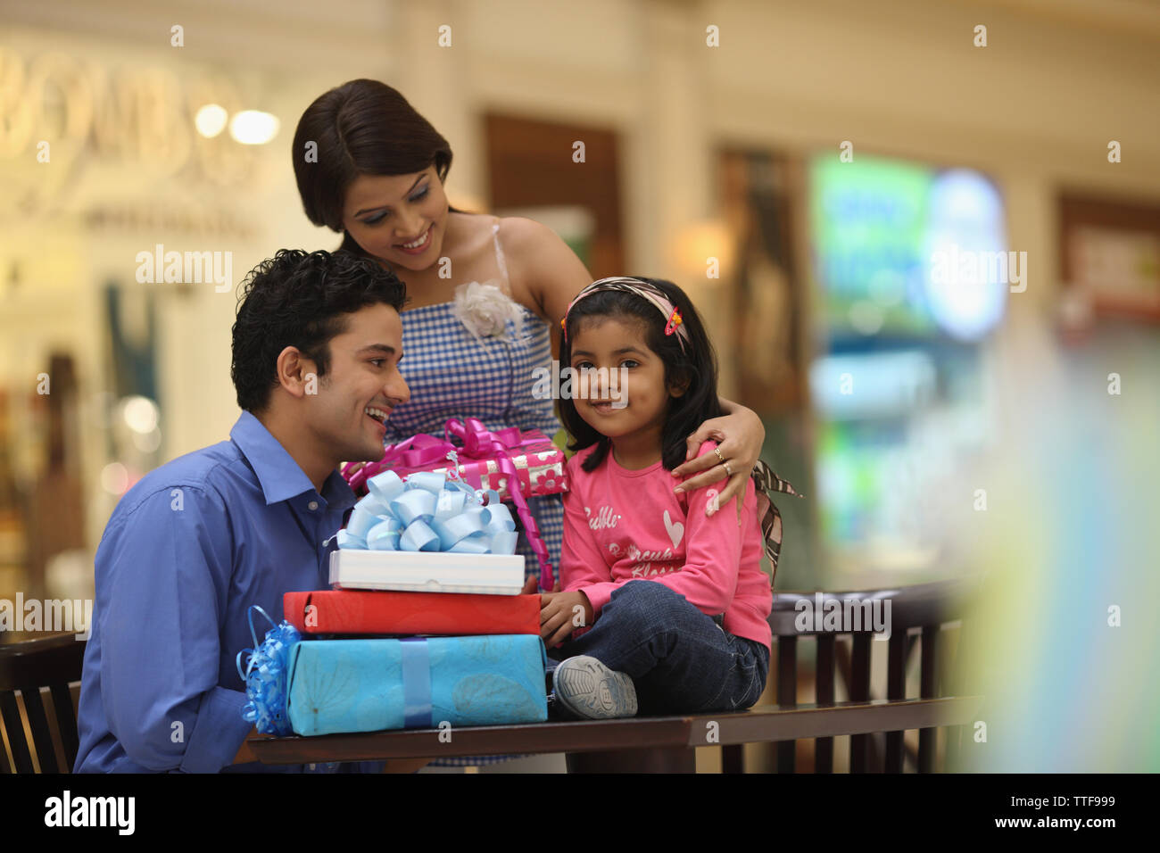 Family with gifts in a shopping mall Stock Photo - Alamy