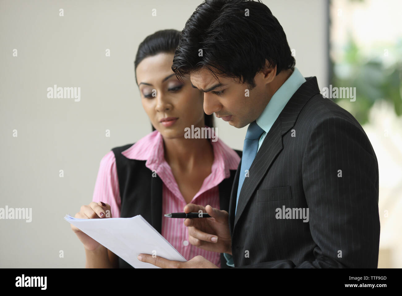 Two business executives going over documents Stock Photo - Alamy