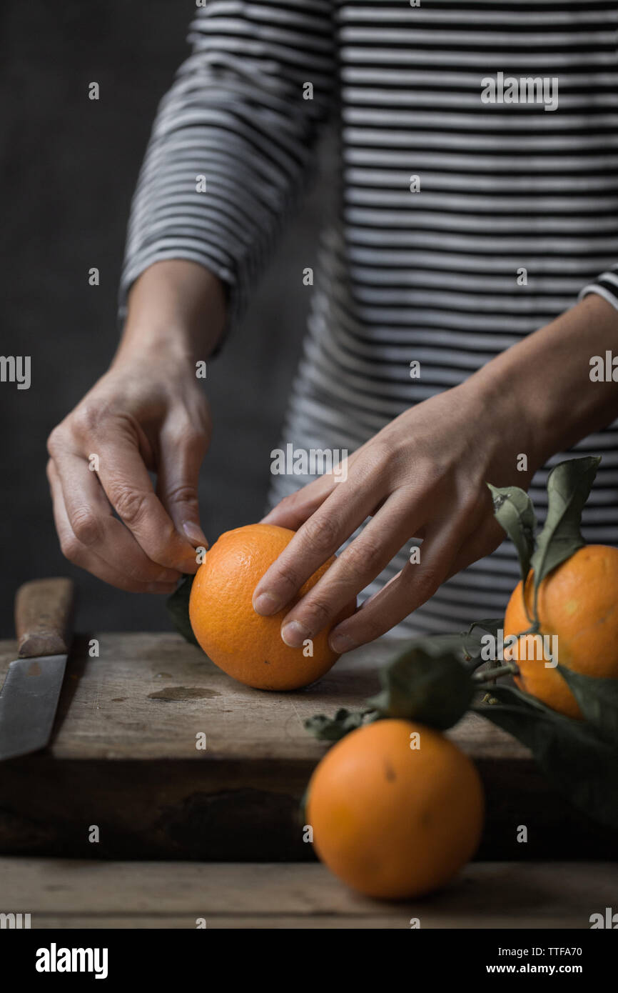 Hand cutting orange hi-res stock photography and images - Alamy