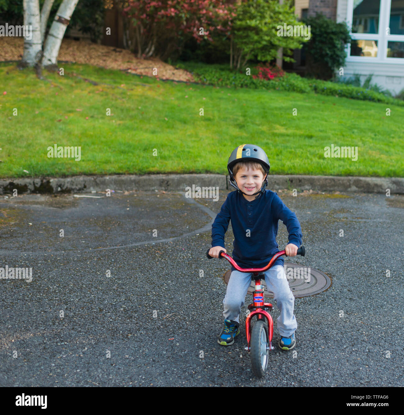 Portrait of boy riding bicycle on road Stock Photo - Alamy