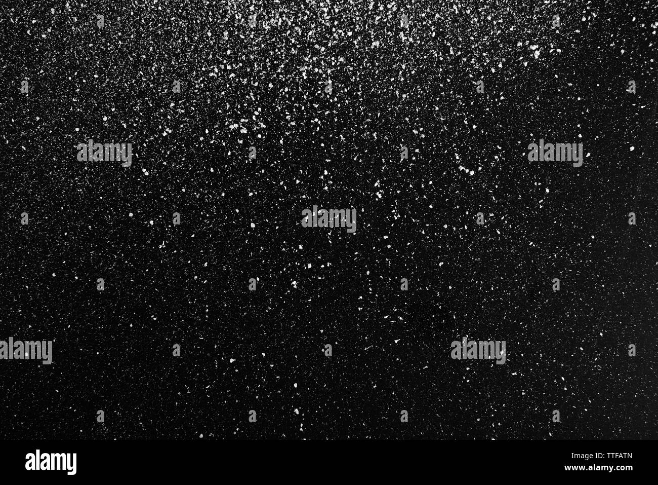 Snow flakes on black backdrop Black and White Stock Photos & Images - Alamy