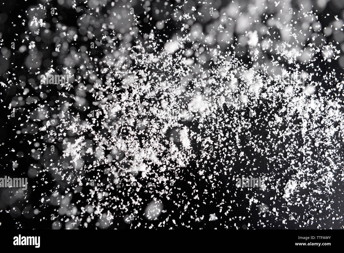 Snow flakes on dark background Stock Photo - Alamy