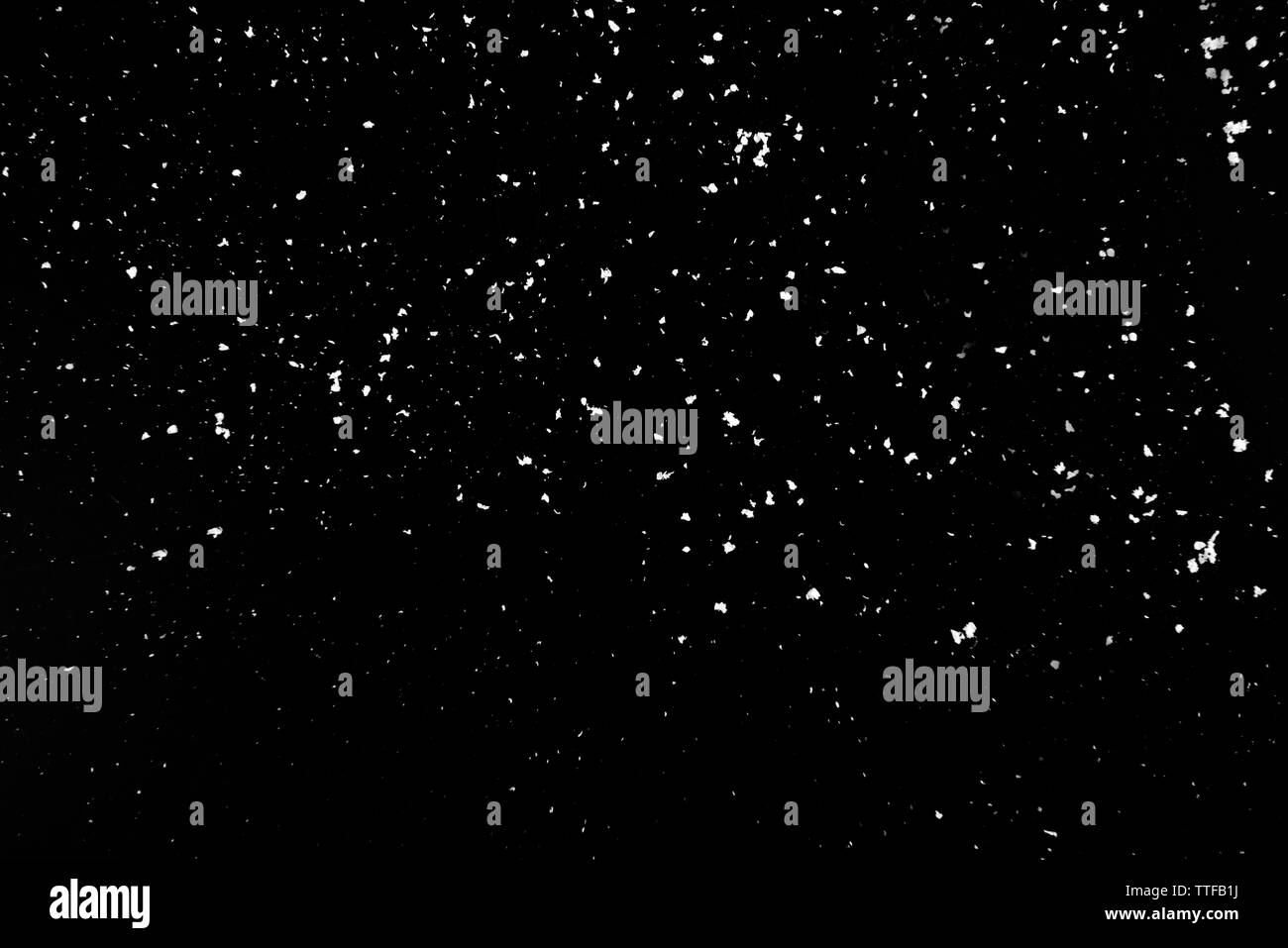 Snow flakes on black backdrop Black and White Stock Photos & Images - Alamy