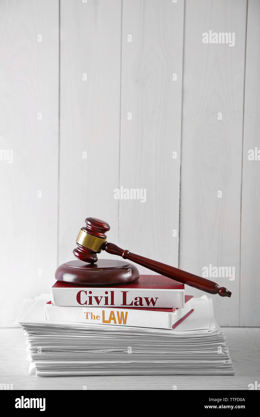 Gavel on stack of paper and books books on wooden background Stock ...
