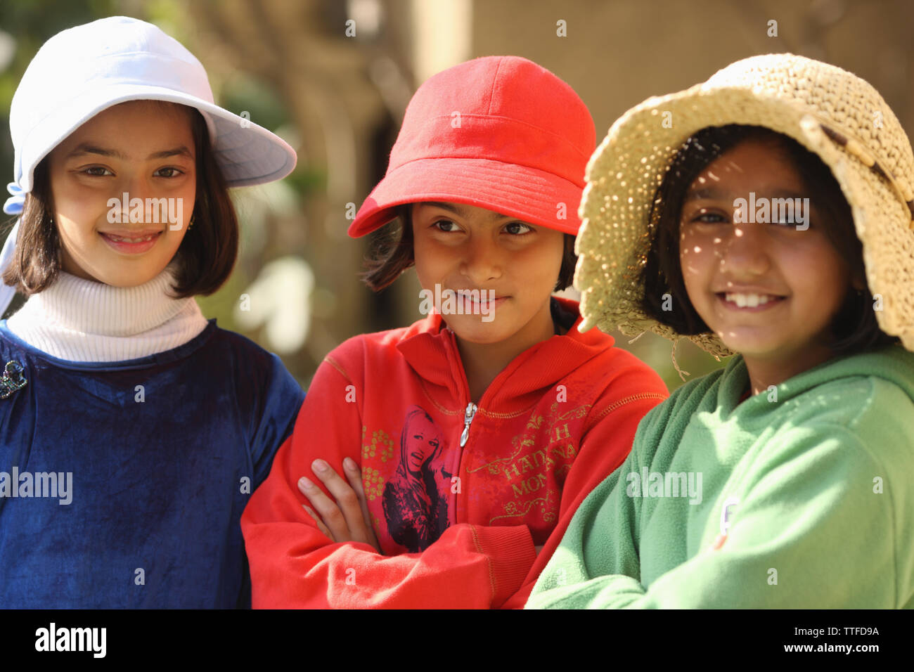 Three friends smiling together Stock Photo - Alamy