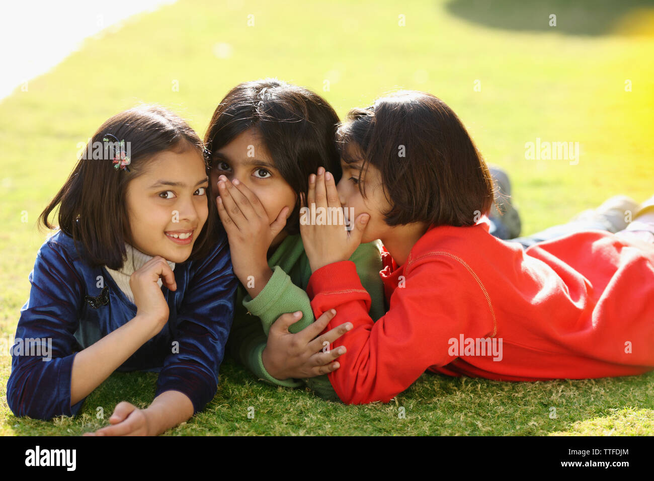 Children whispering group hi-res stock photography and images - Alamy