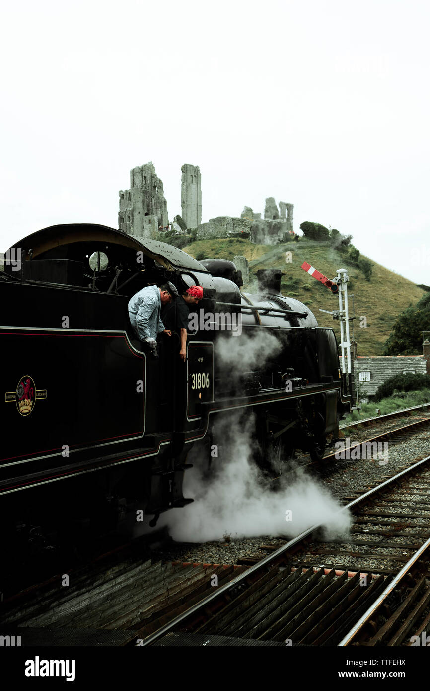 Machinists look out of an old English train in the village of Korf ...