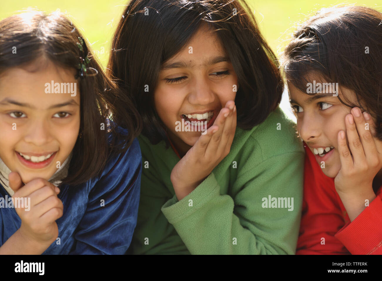 Three girls smiling Stock Photo - Alamy