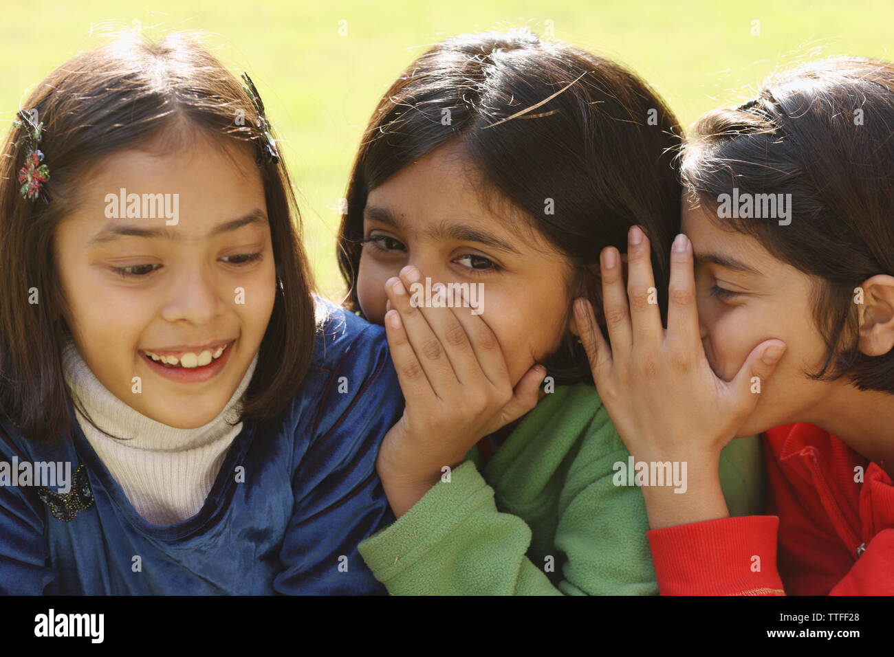 Girls whispering to her friends Stock Photo - Alamy