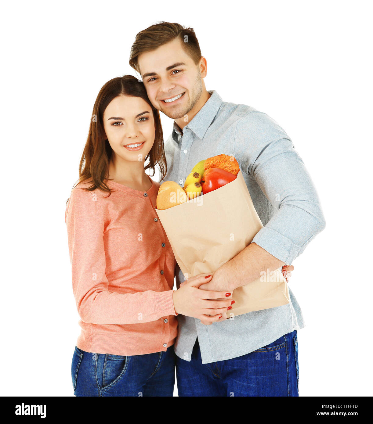 Young couple with paper bag of products isolated on white Stock Photo ...