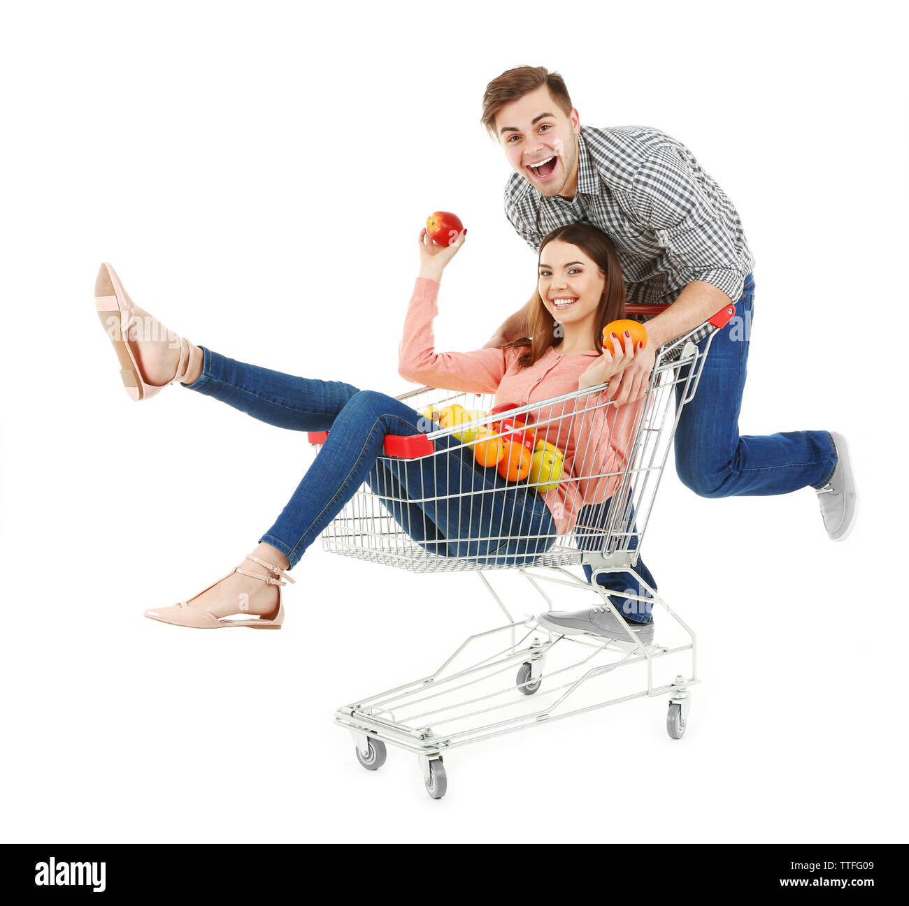 Man carrying woman in metal trolley with products isolated on white ...