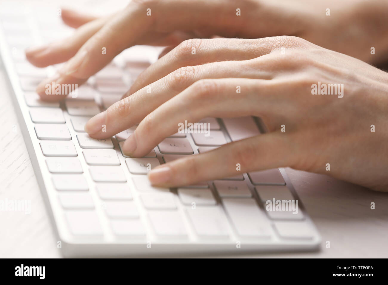 Female hands using keyboard on white wooden table, close up Stock Photo ...