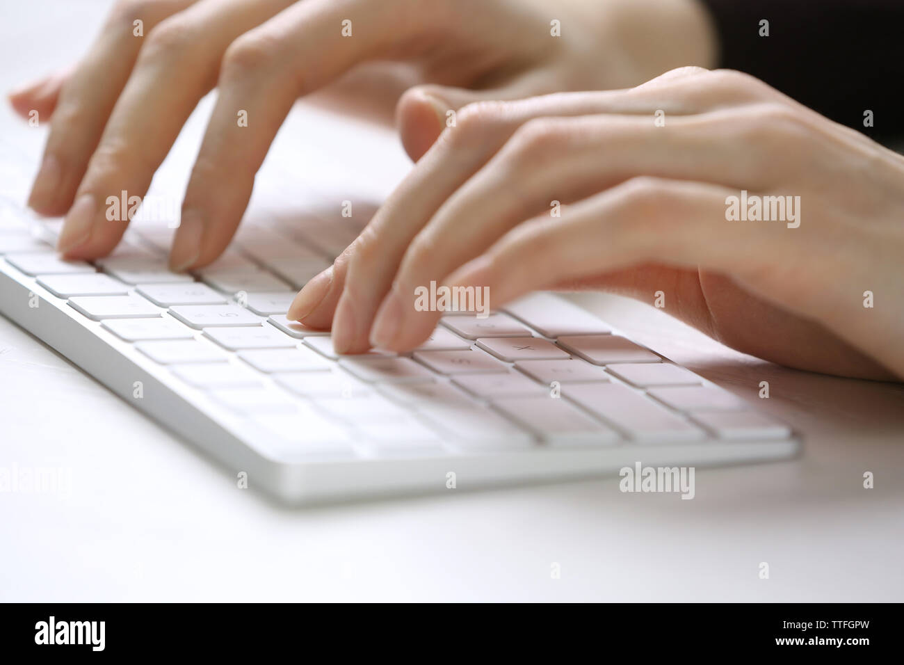 Female hands using keyboard on white wooden table, close up Stock Photo ...