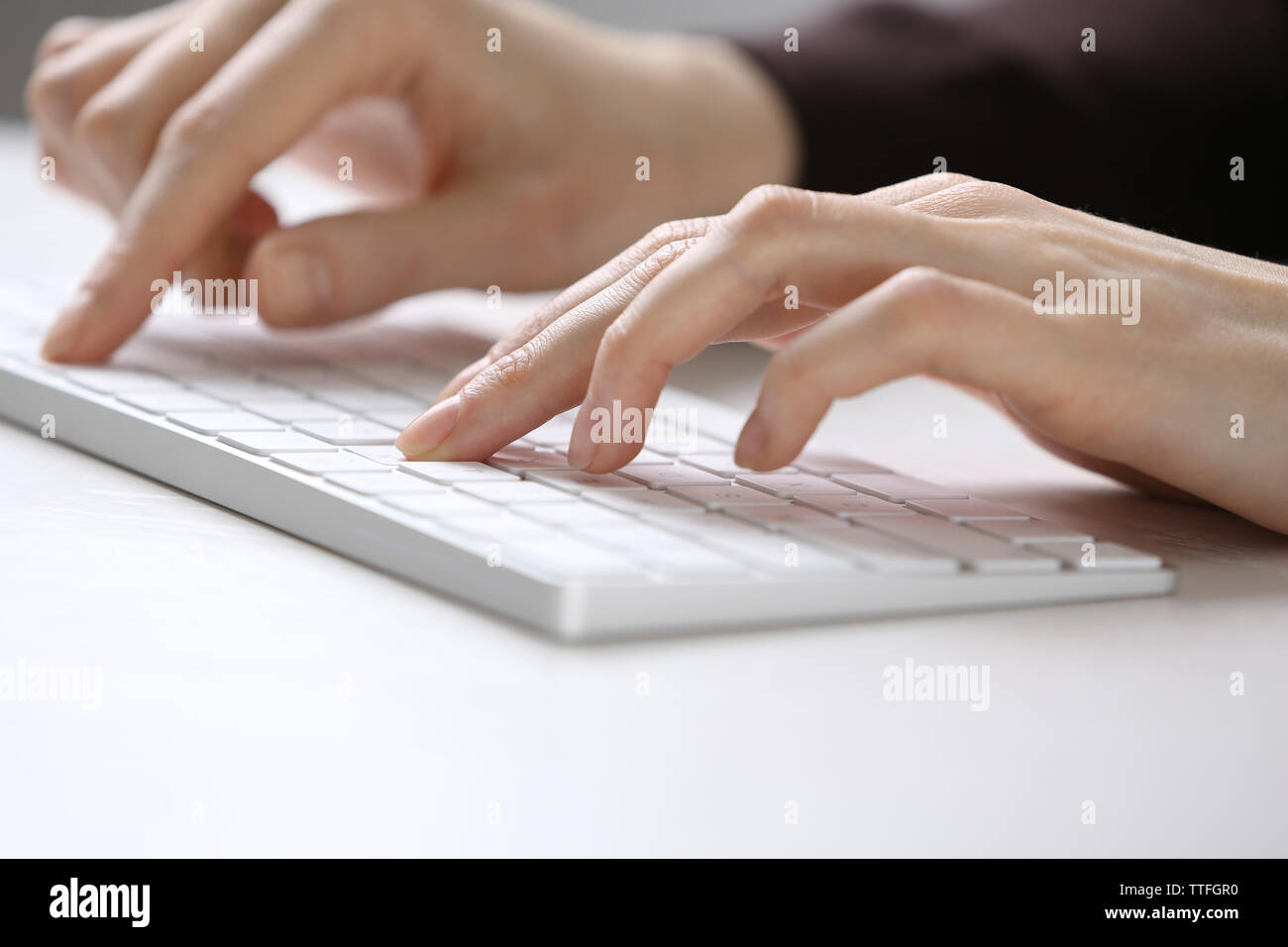 Female hands using keyboard on white wooden table, close up Stock Photo ...