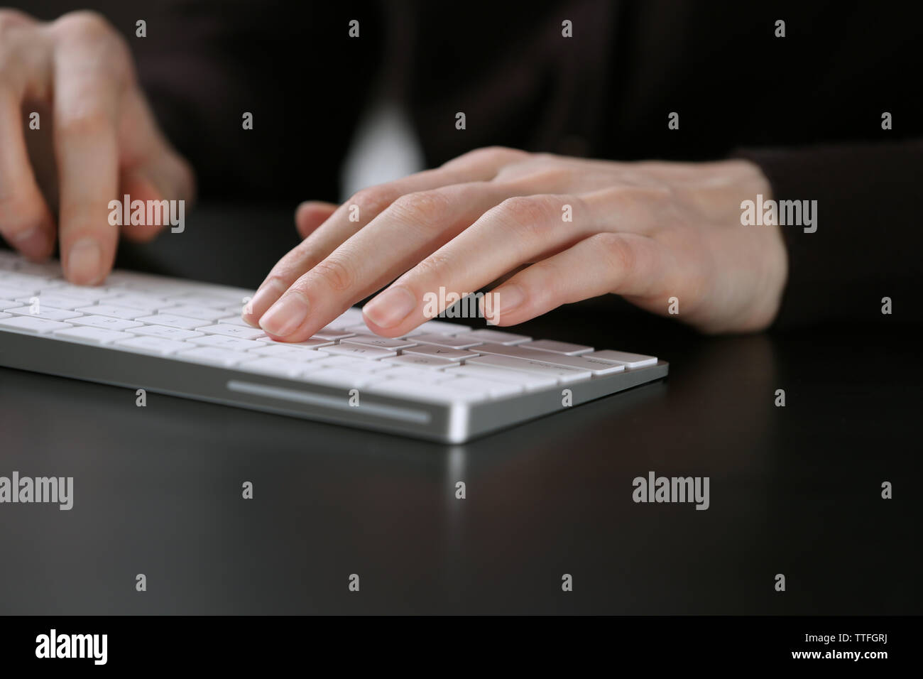 Female hands using keyboard on dark wooden table, close up Stock Photo ...