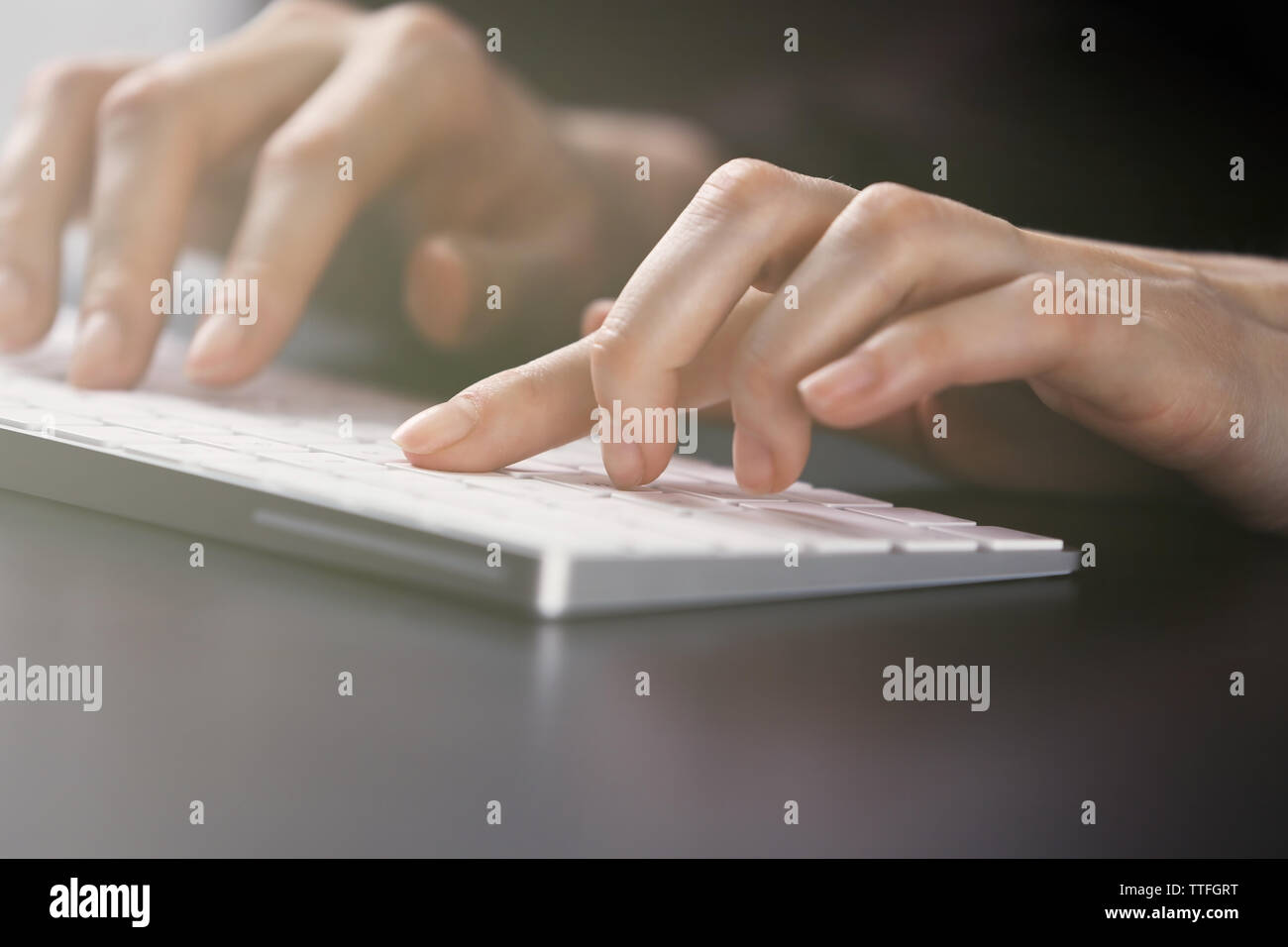 Female hands using keyboard on dark wooden table, close up Stock Photo - Alamy