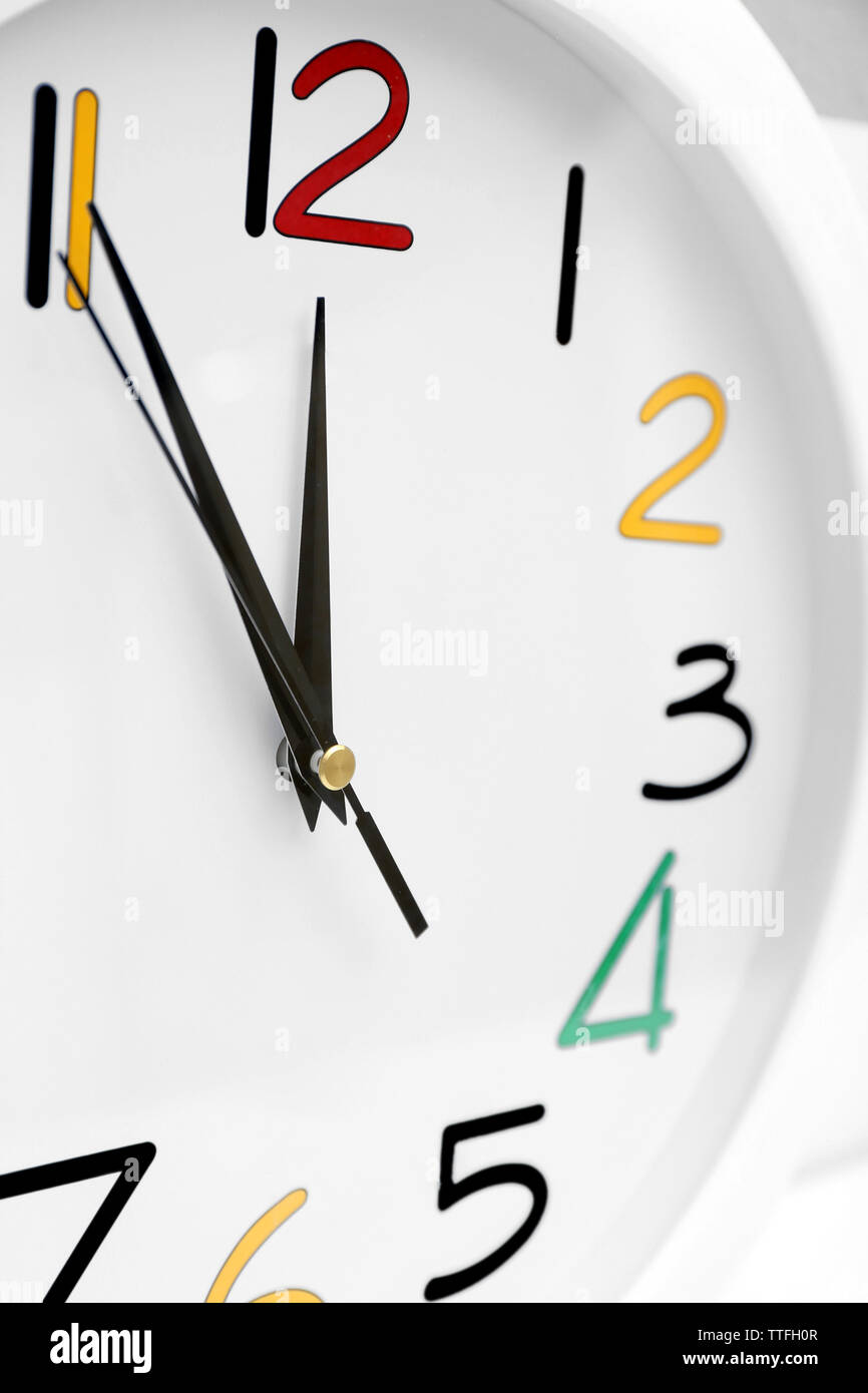 Round wall clock with colorful figures, close up Stock Photo - Alamy