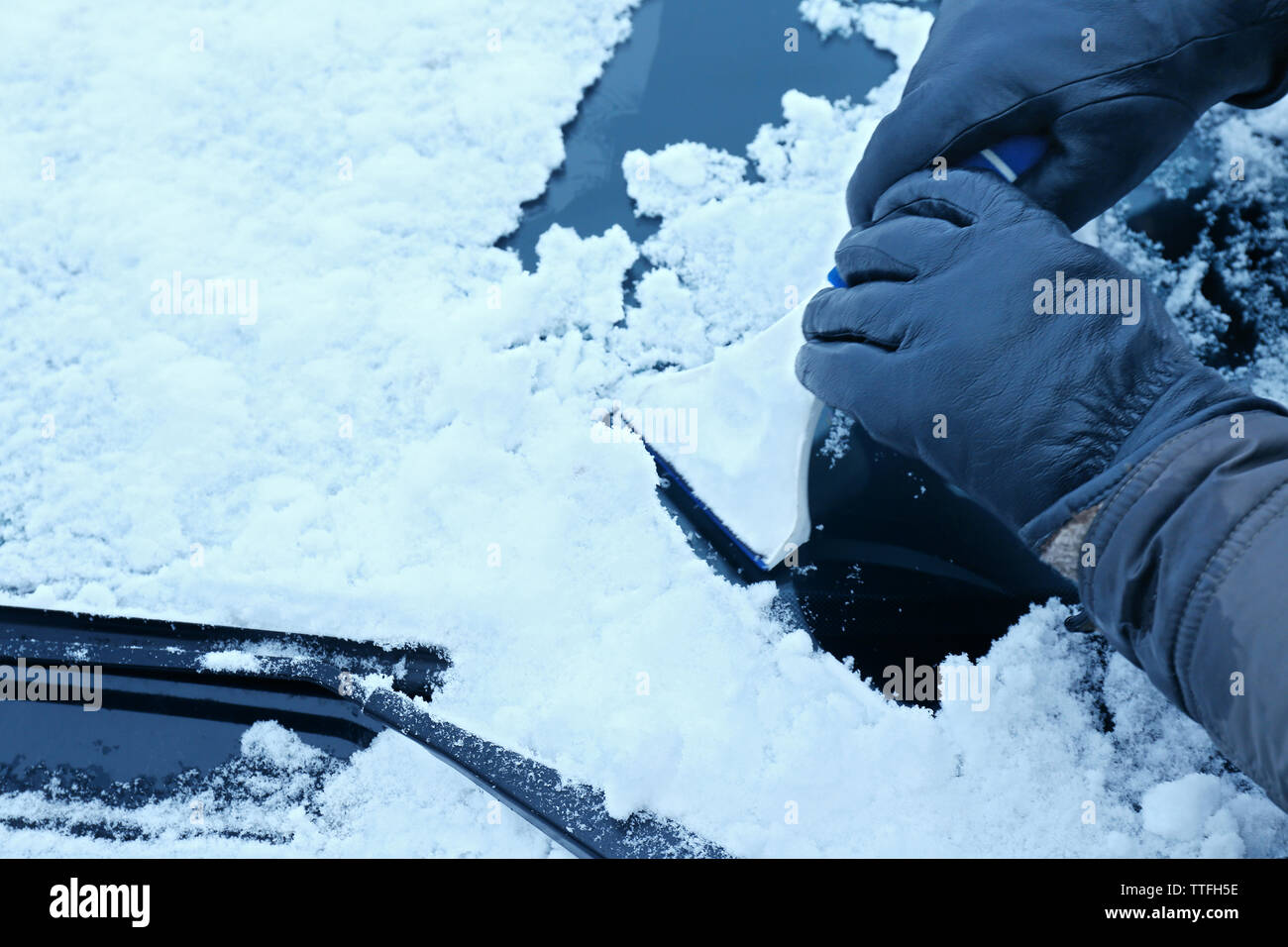 Removing snow from car windshield, closeup Stock Photo - Alamy