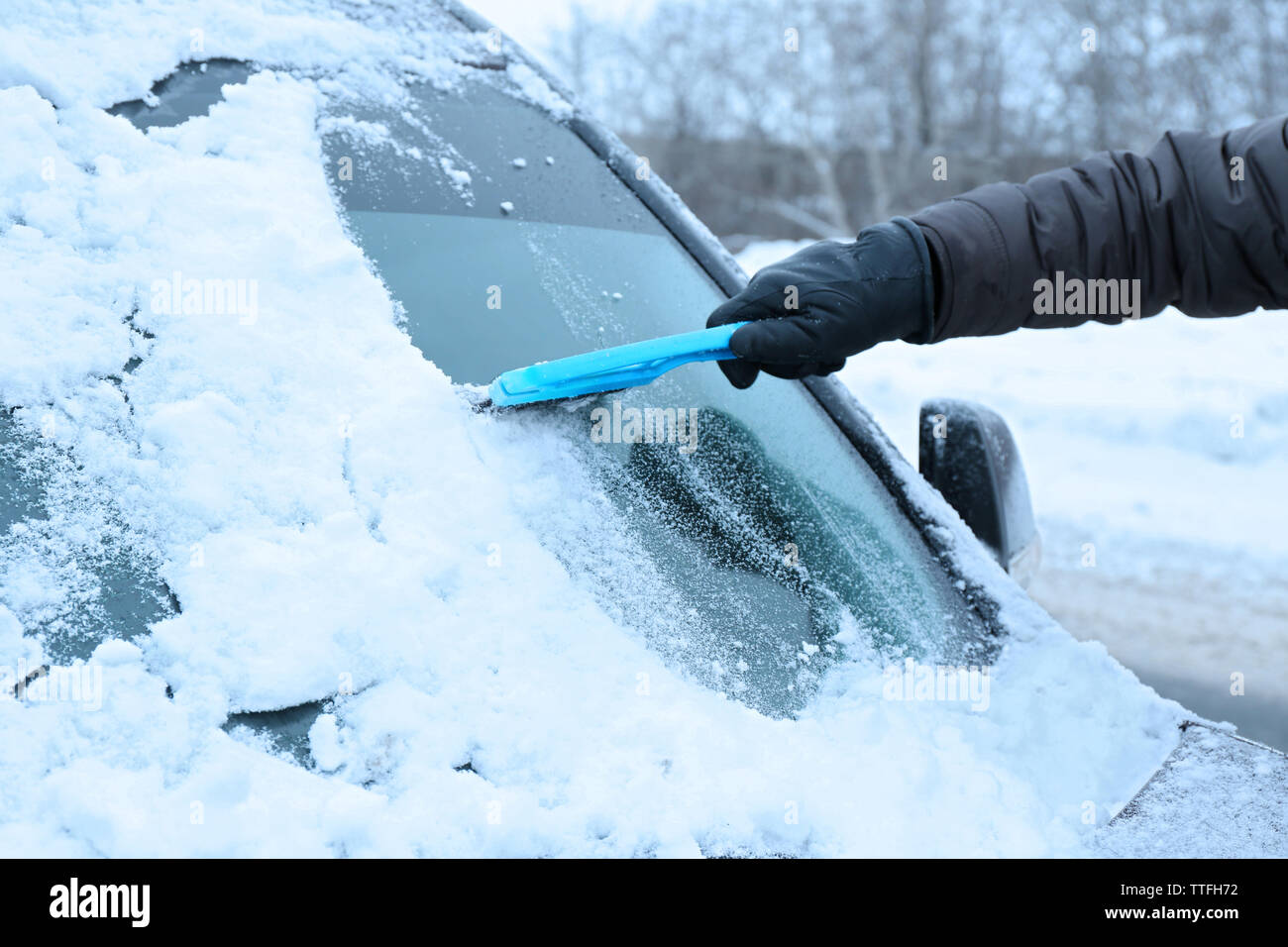 Removing snow from car windshield, closeup Stock Photo - Alamy