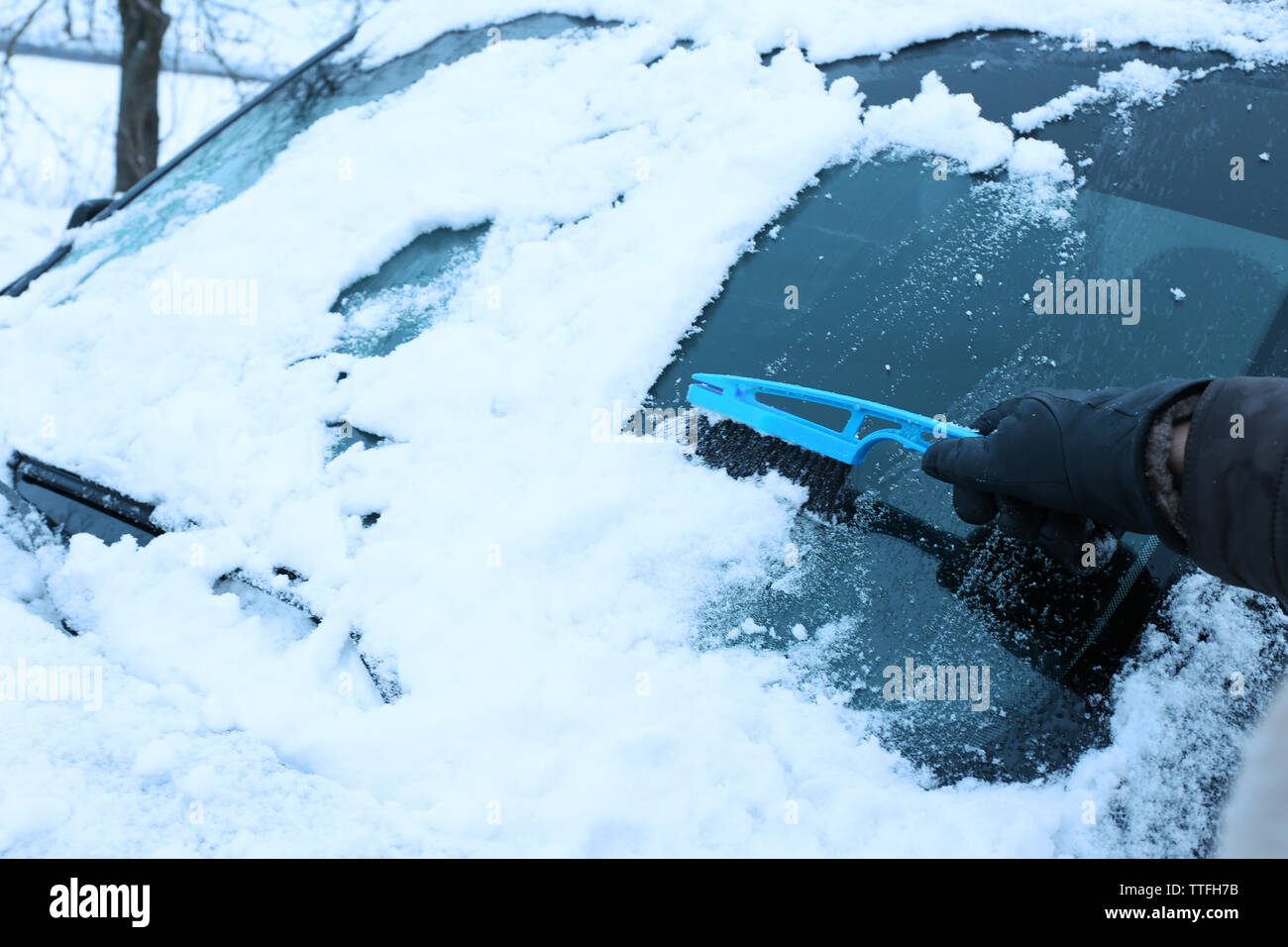 Removing snow from car windshield, closeup Stock Photo - Alamy