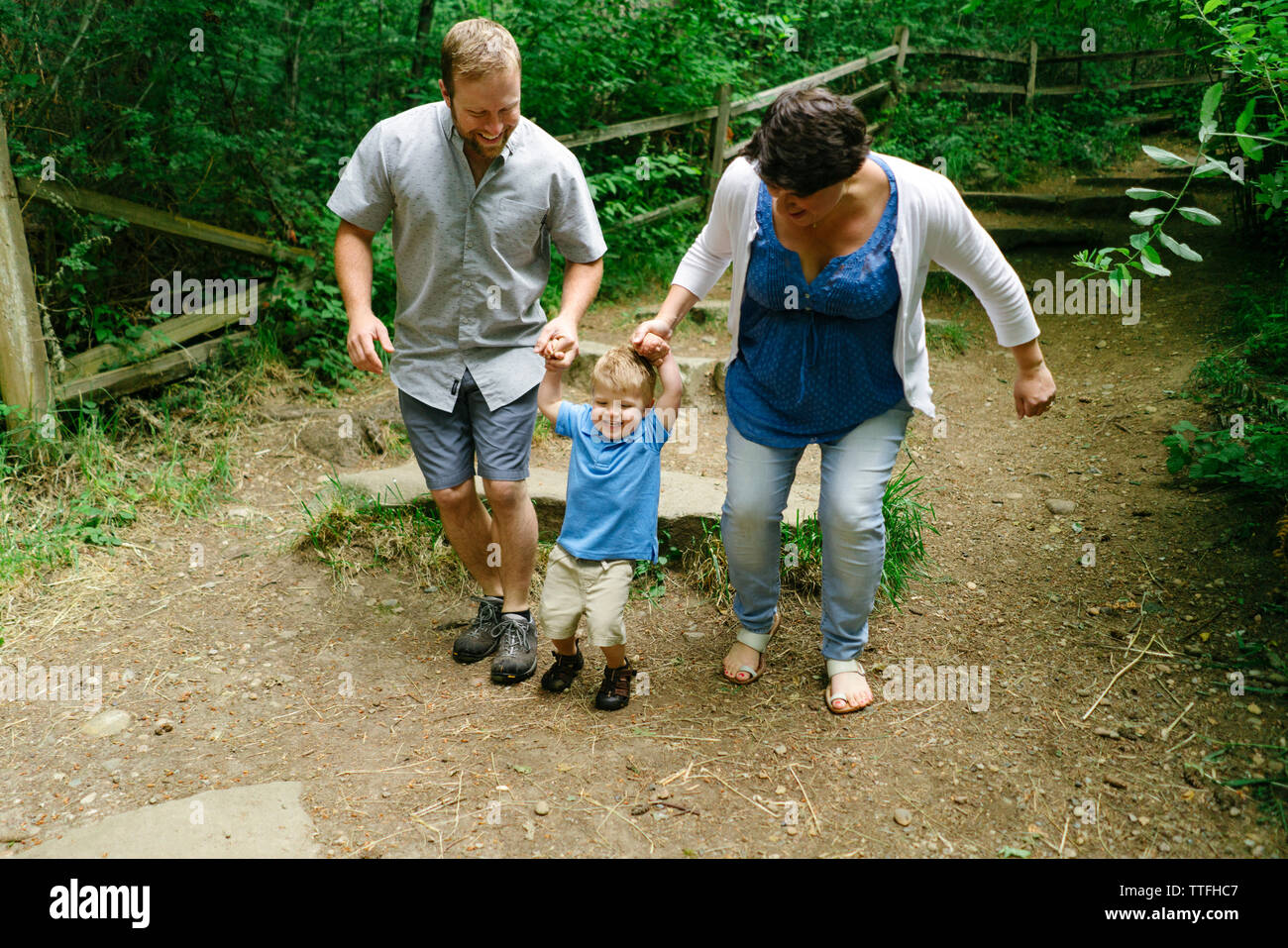 Family holding hands jumping on hi-res stock photography and images - Alamy