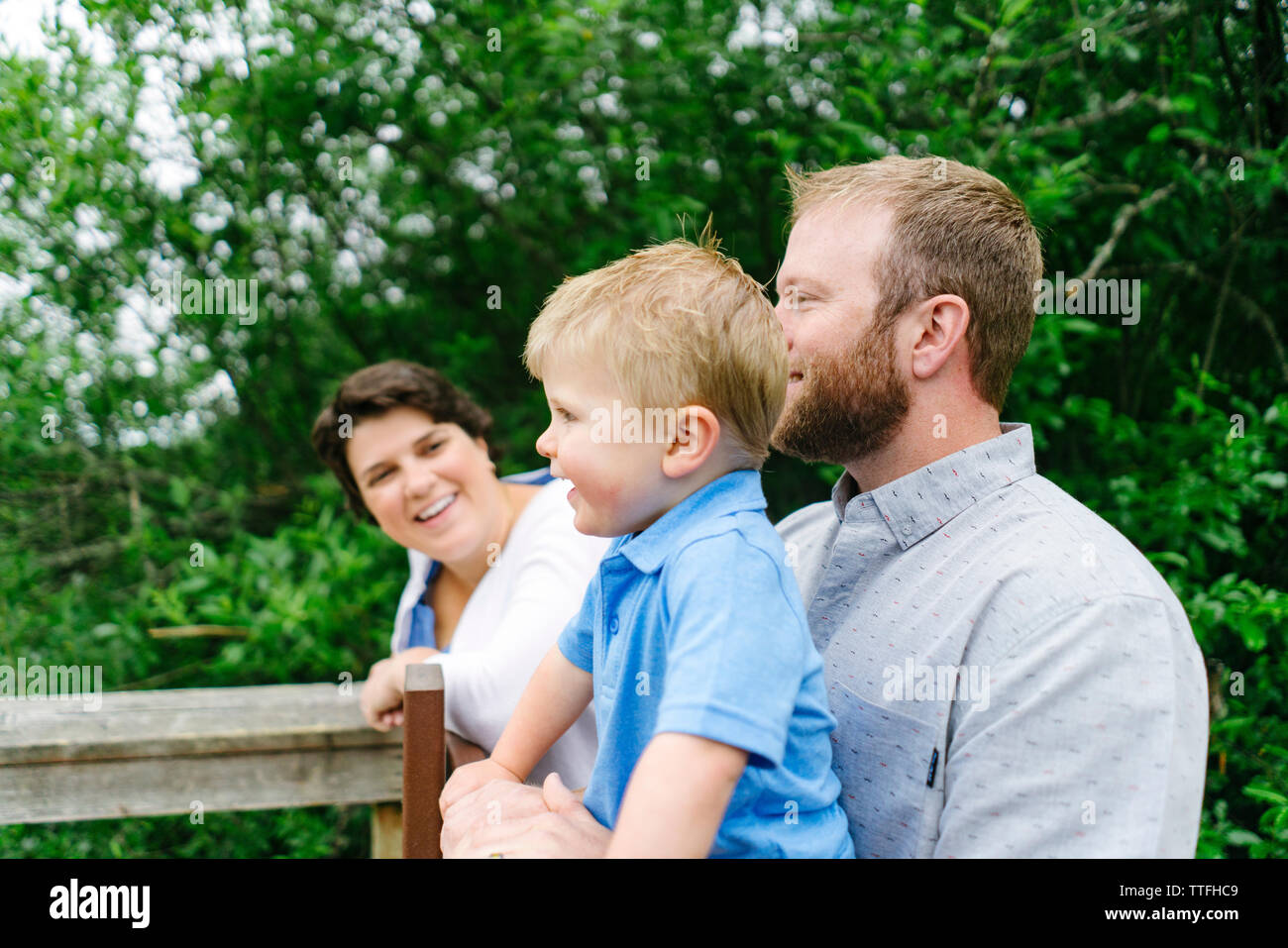 Side view of a young family smiling together Stock Photo - Alamy