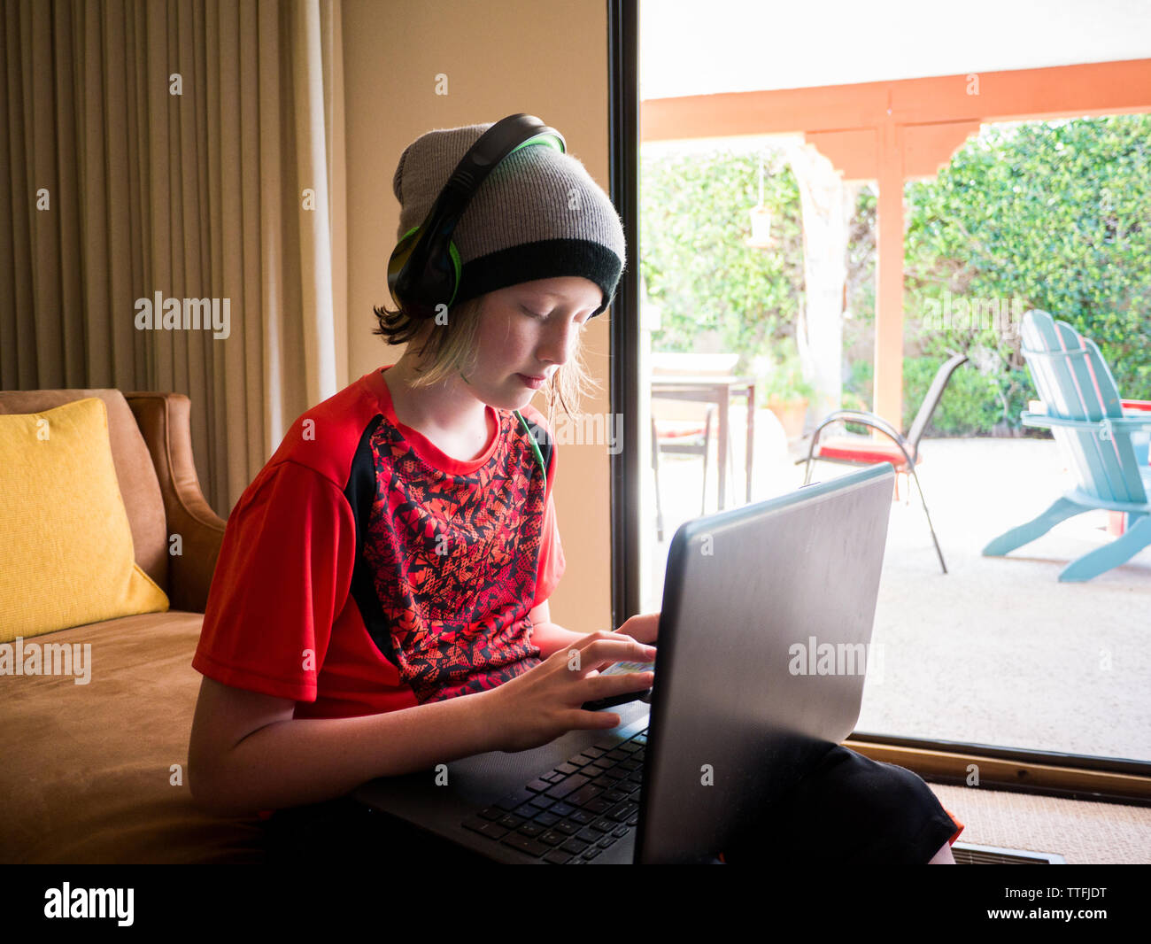 Boy using computer with headphones hi-res stock photography and images ...